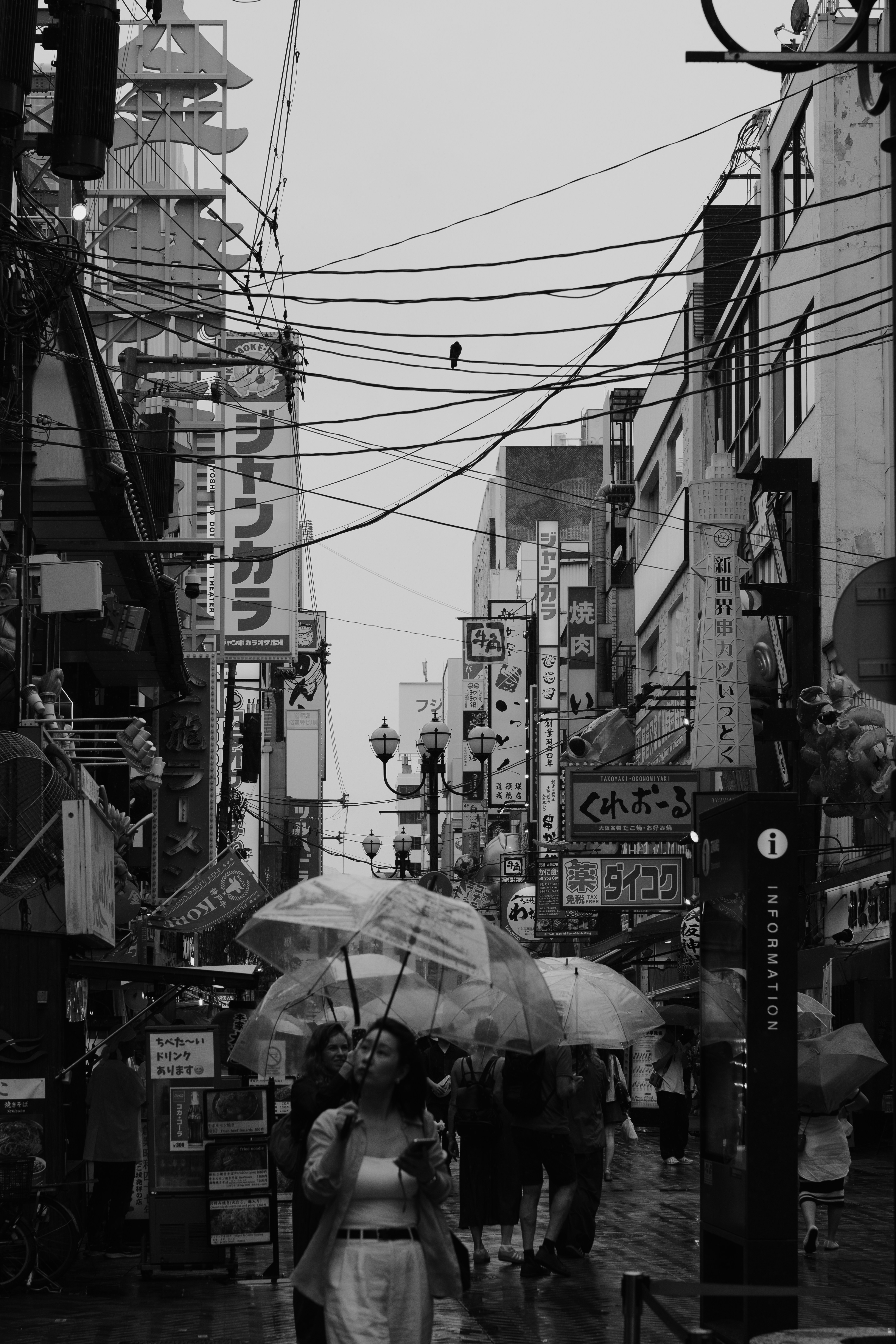 Neon Alley in Rain: Umbrellas and Wires Over a Shady Japanese Street