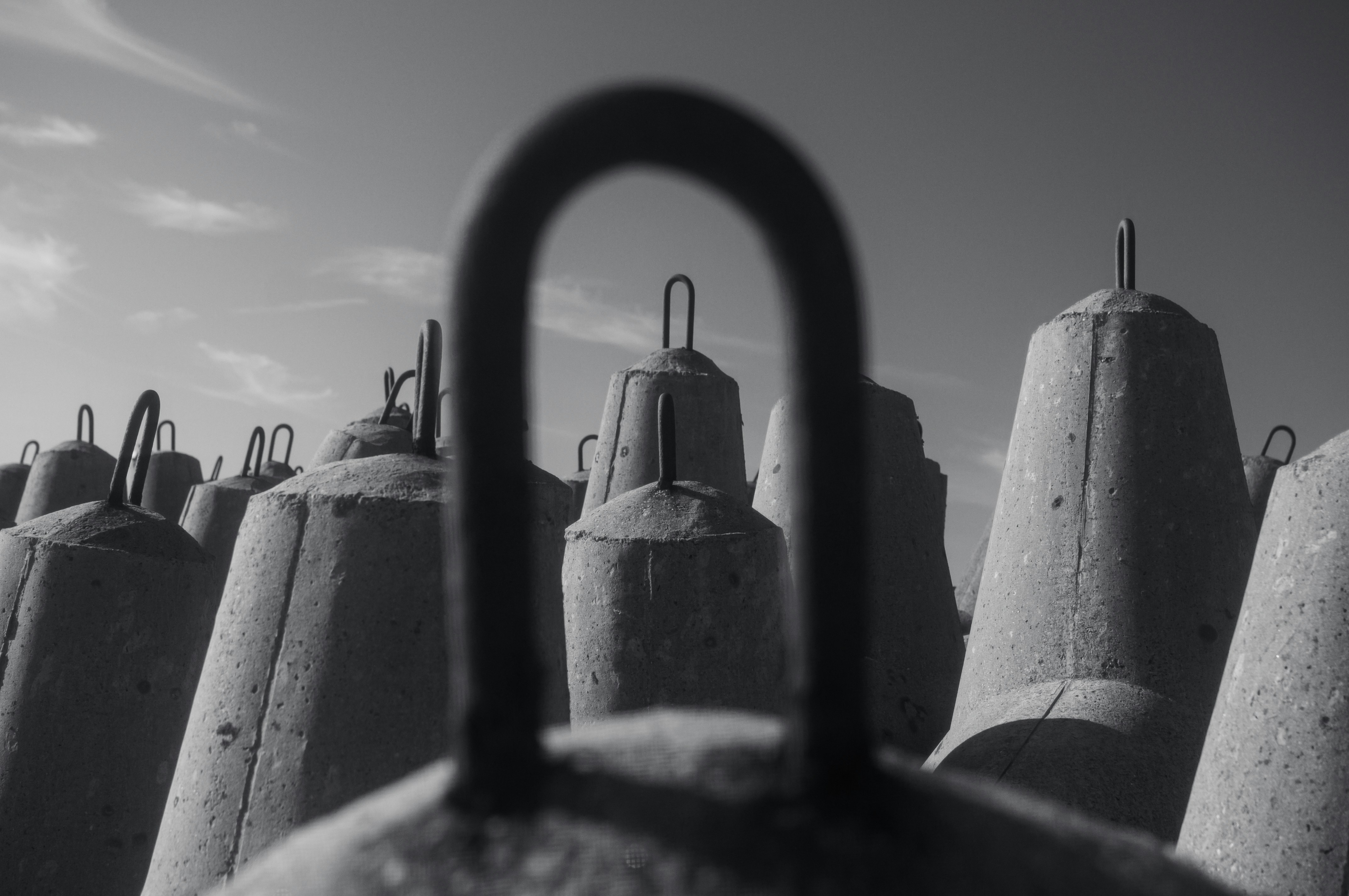Locked In Focus: A Foreground Padlock Framing Industrial Silhouettes