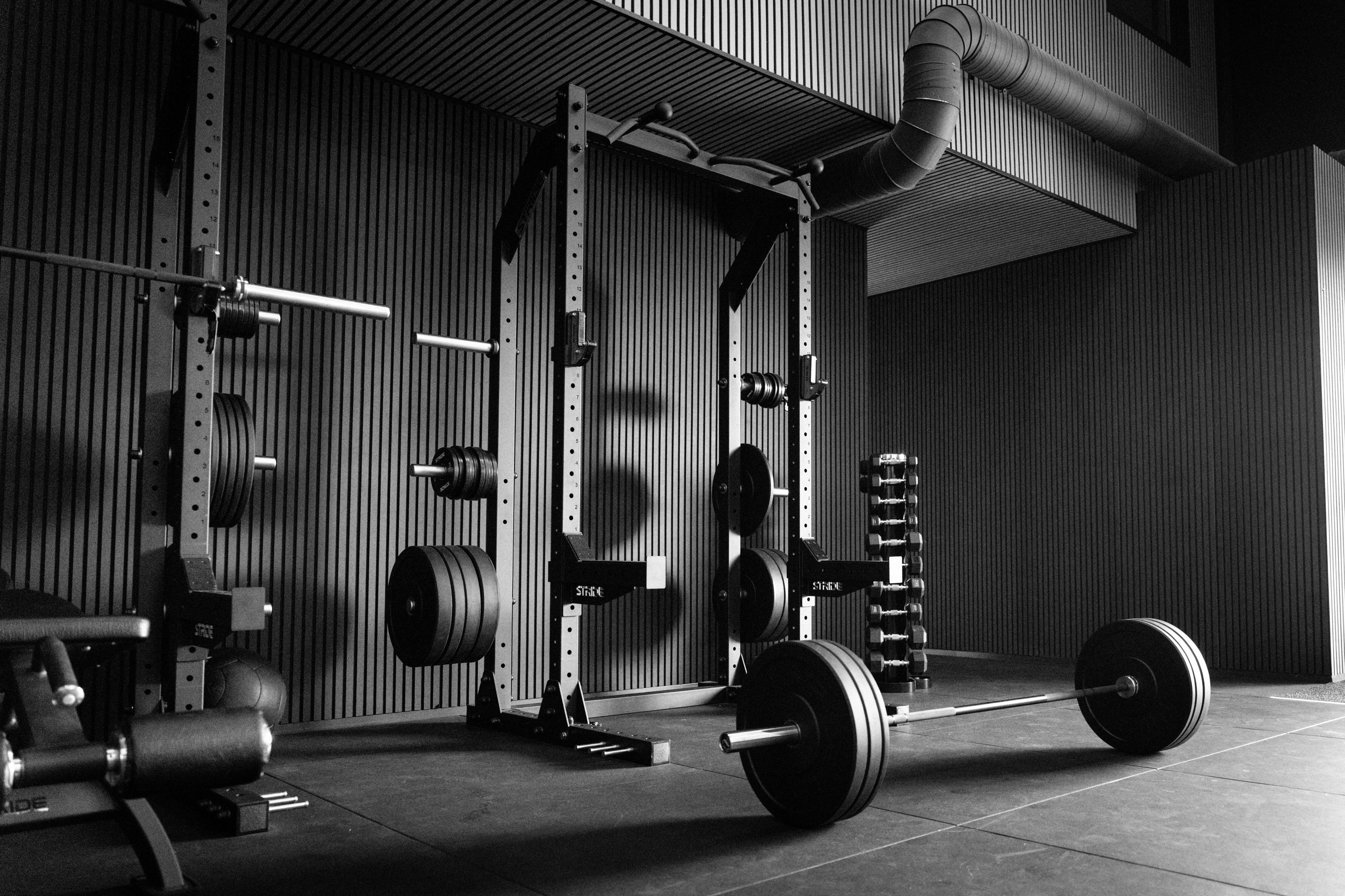 Weight Room in Quiet Monochrome: Barbell Rest Between Racks