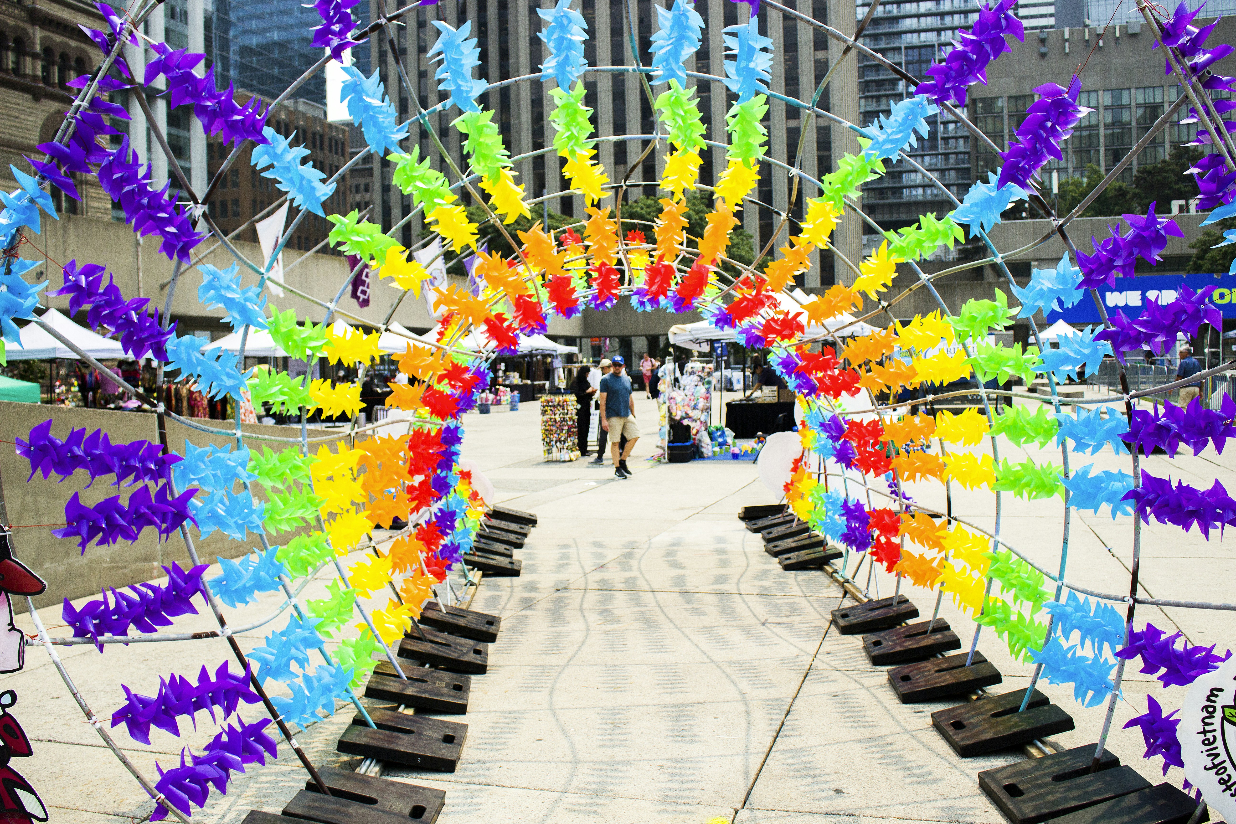 Arc of Color: Rainbow Tunnels Aligned in a Modern Plaza