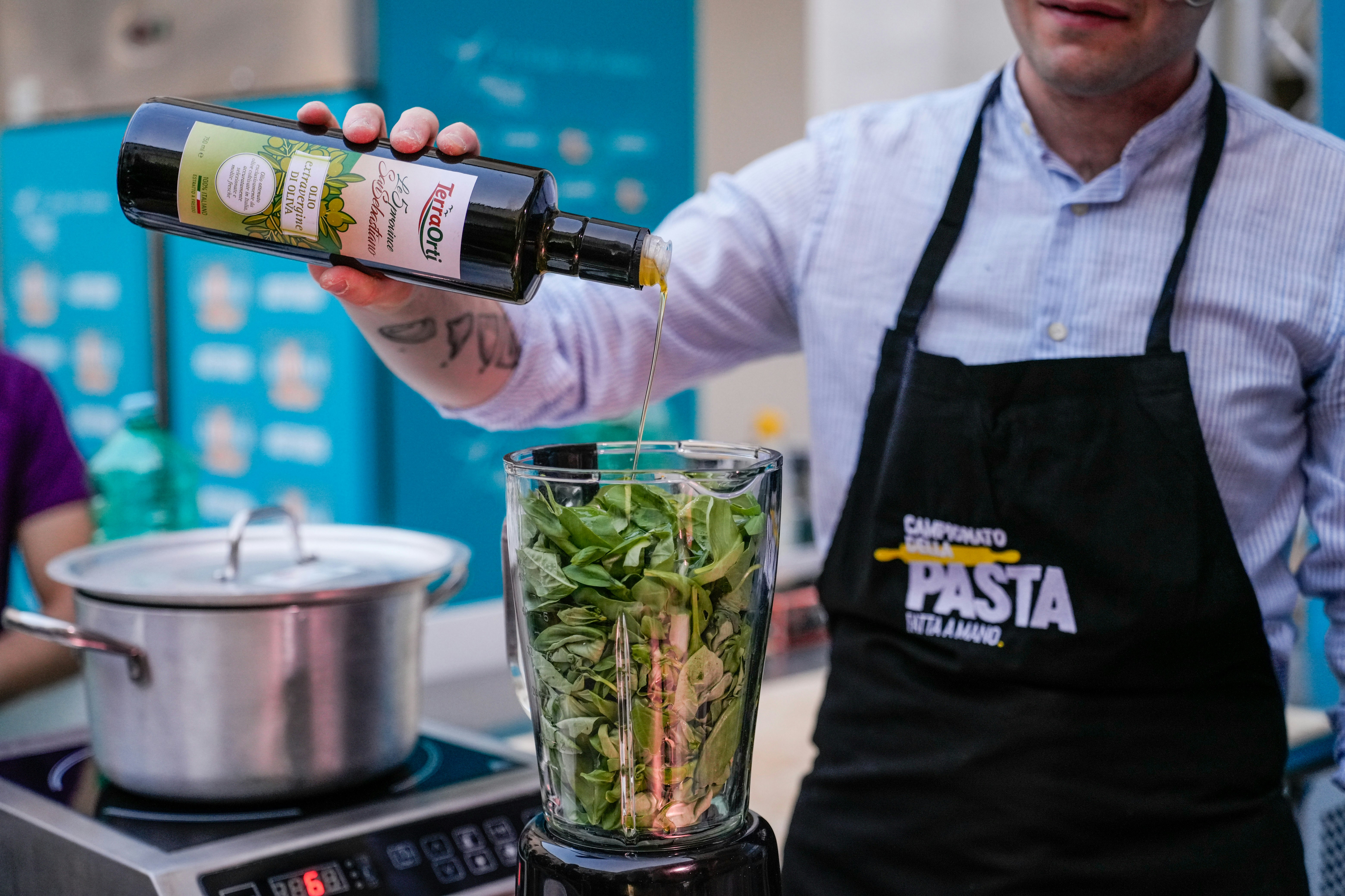 Heritage of Flavor: Pouring Fresh Basil into a Blender