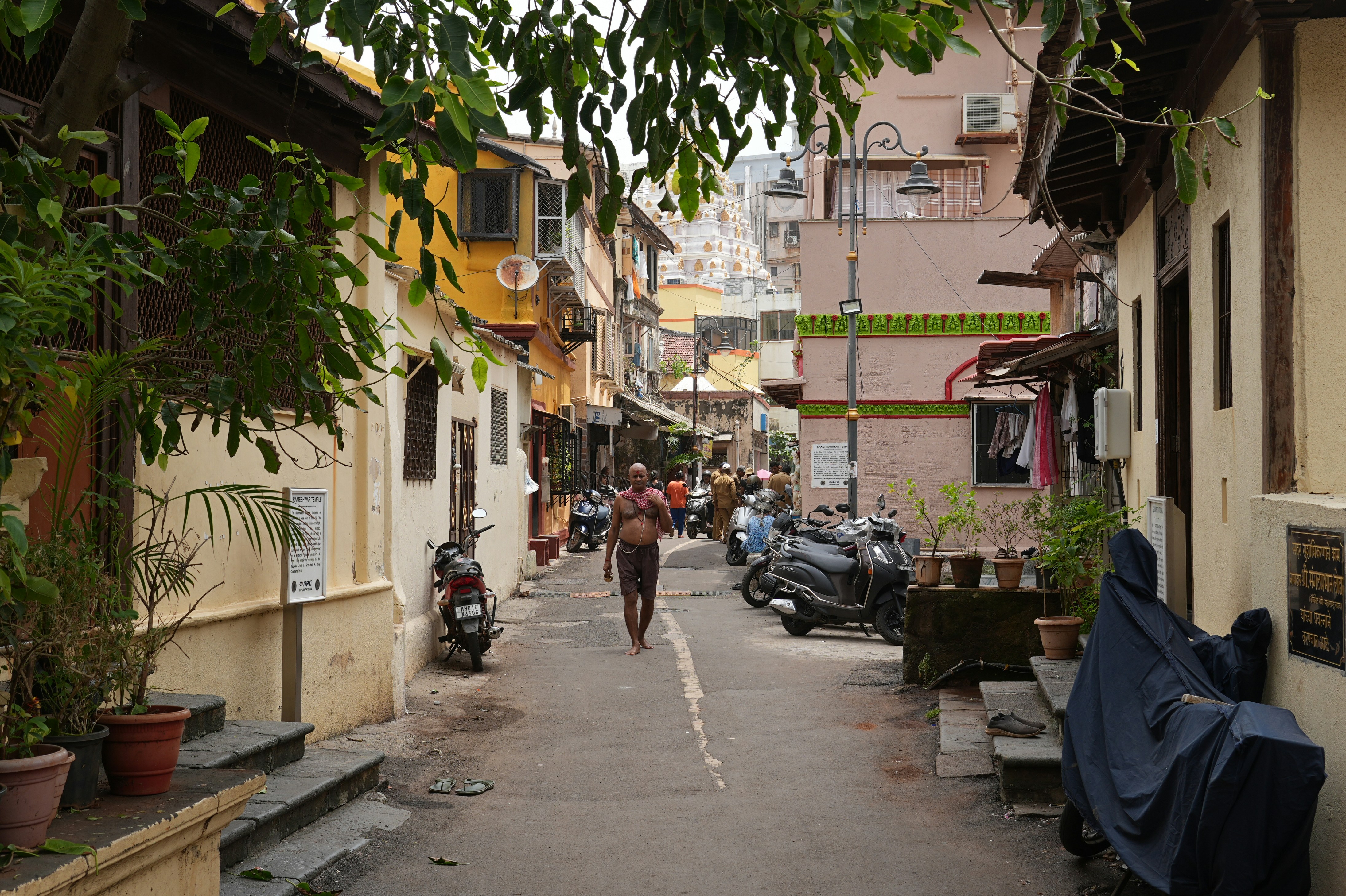 Barefoot Runner Through a Narrow Indian Street