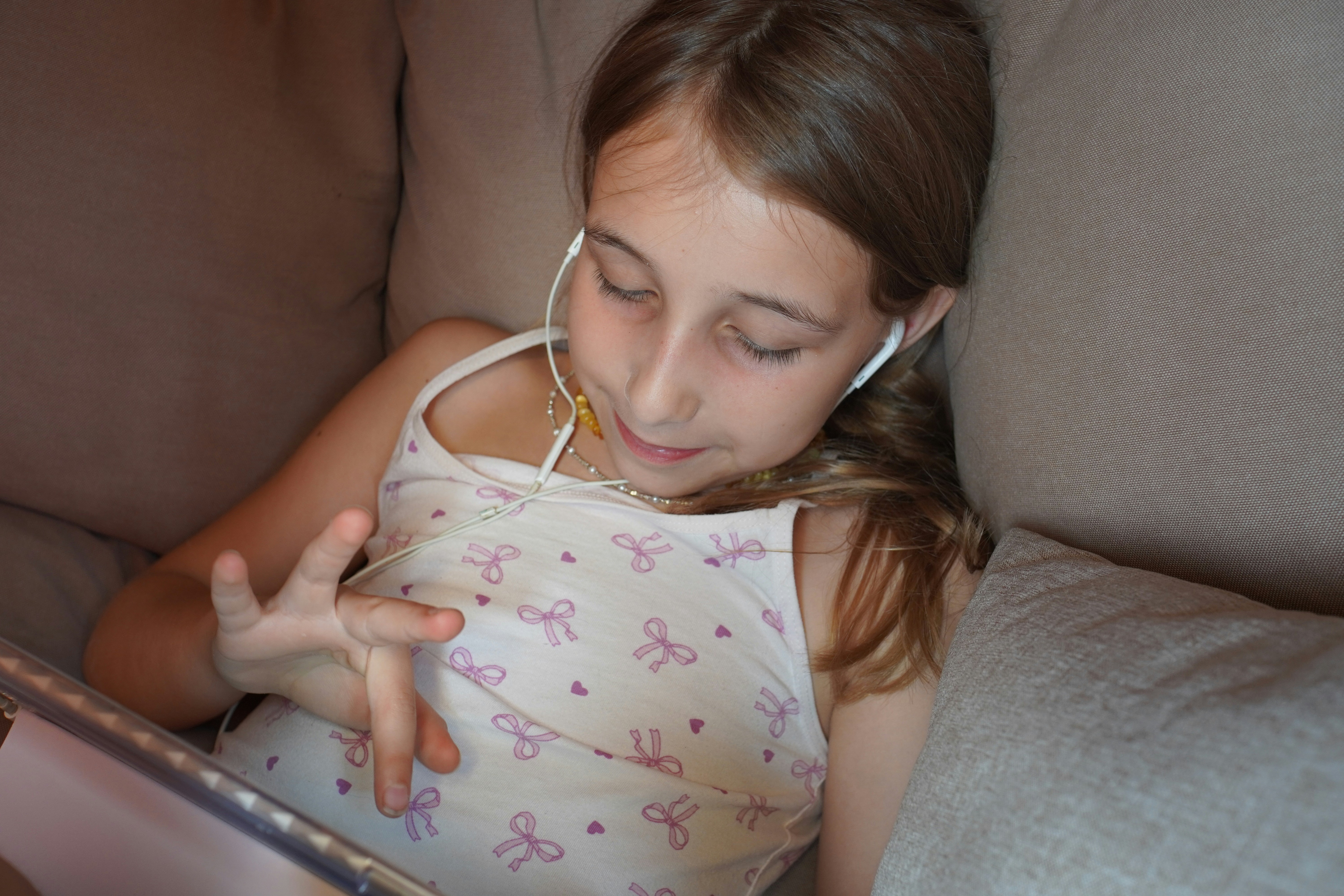 Dreamy Tap on the Tablet: A Quiet Moment on the Couch
