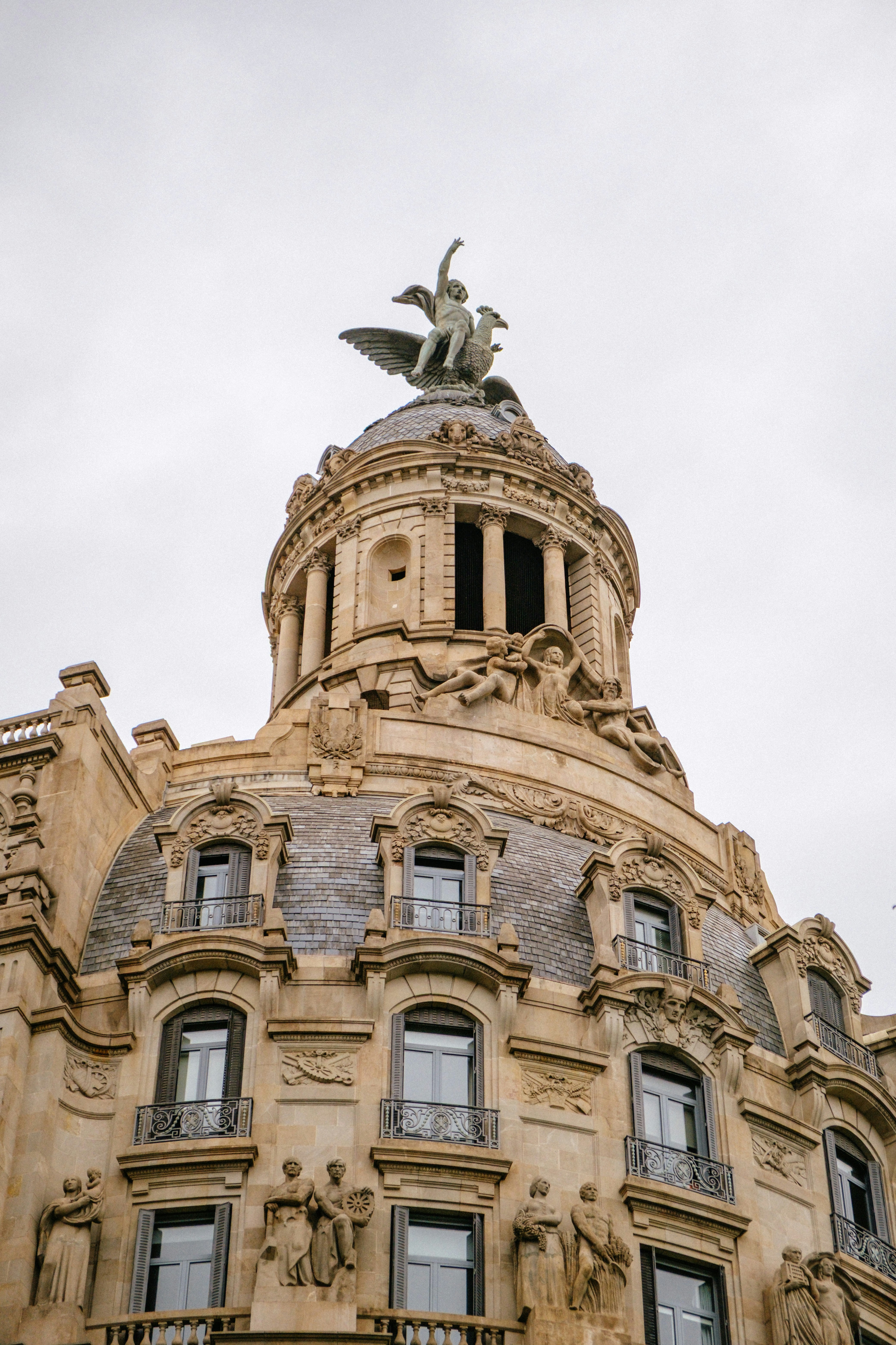 Rising Monumental Dome: Sculpted Facade and Statue Crown the Parisian Roofline