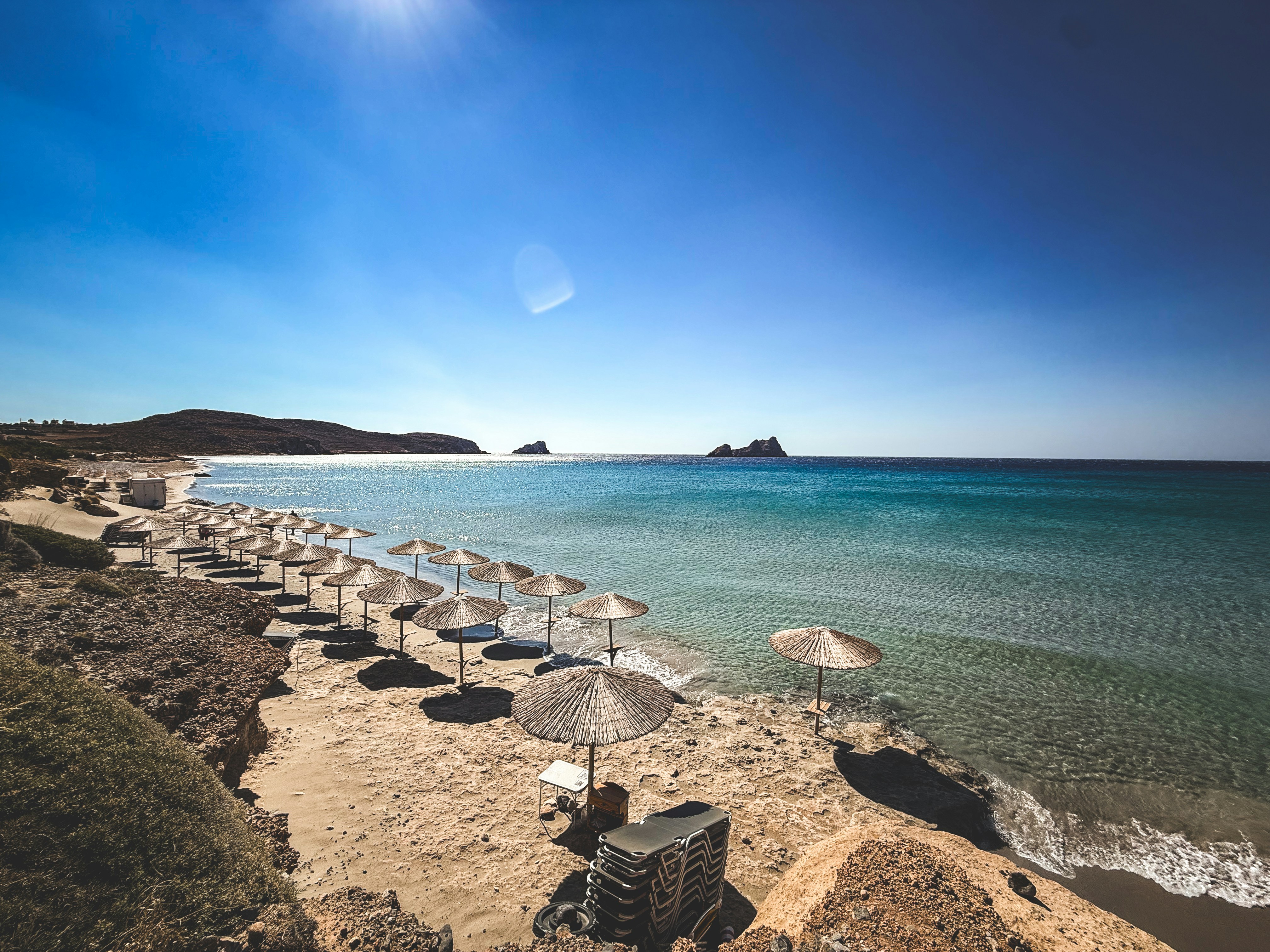 Sunlit Beach Rows: A Quiet Arc of Umbrellas and Ocean