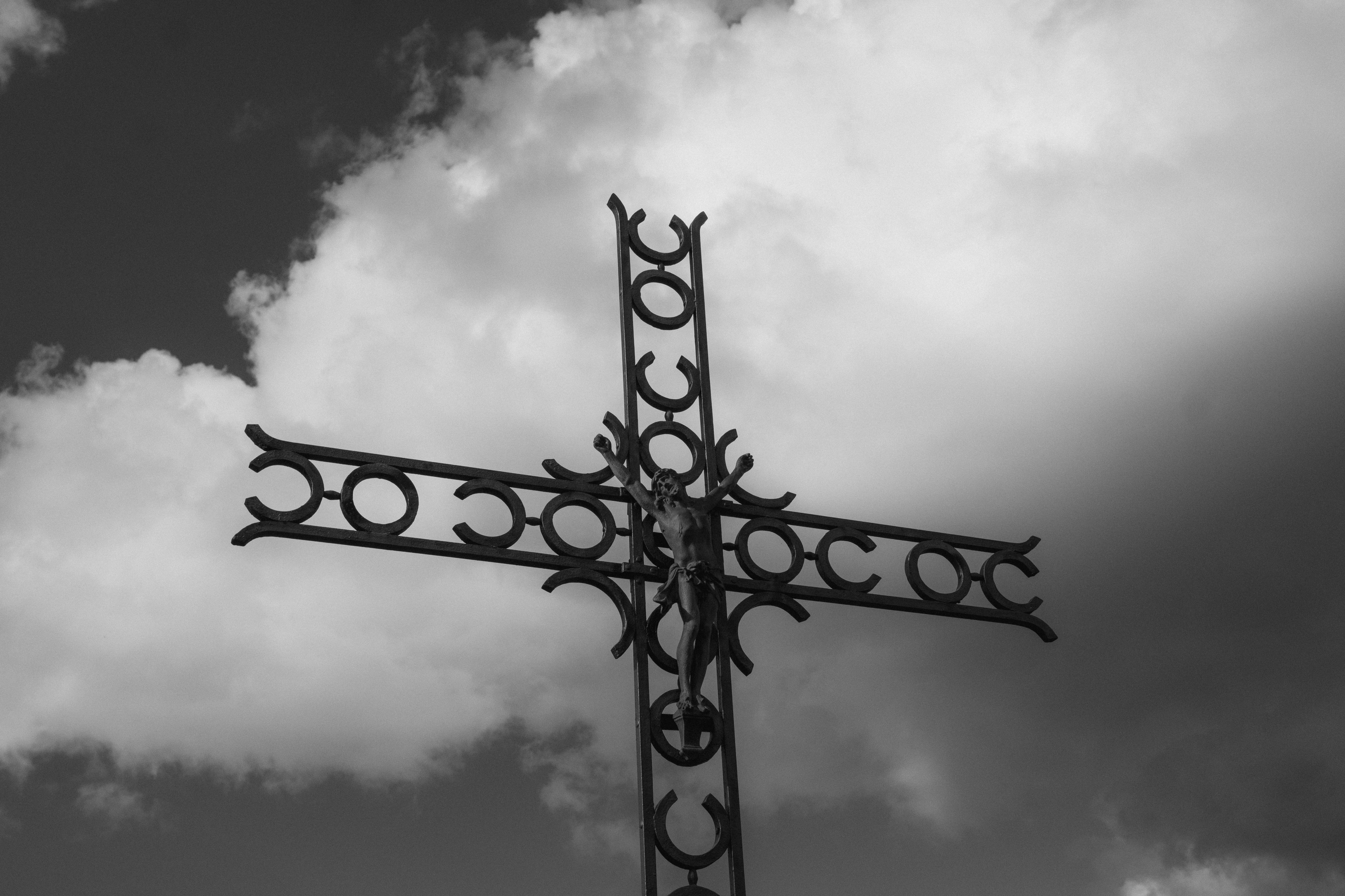 Iron Cross Amid Storm: A Gothic Silhouette in Monochrome