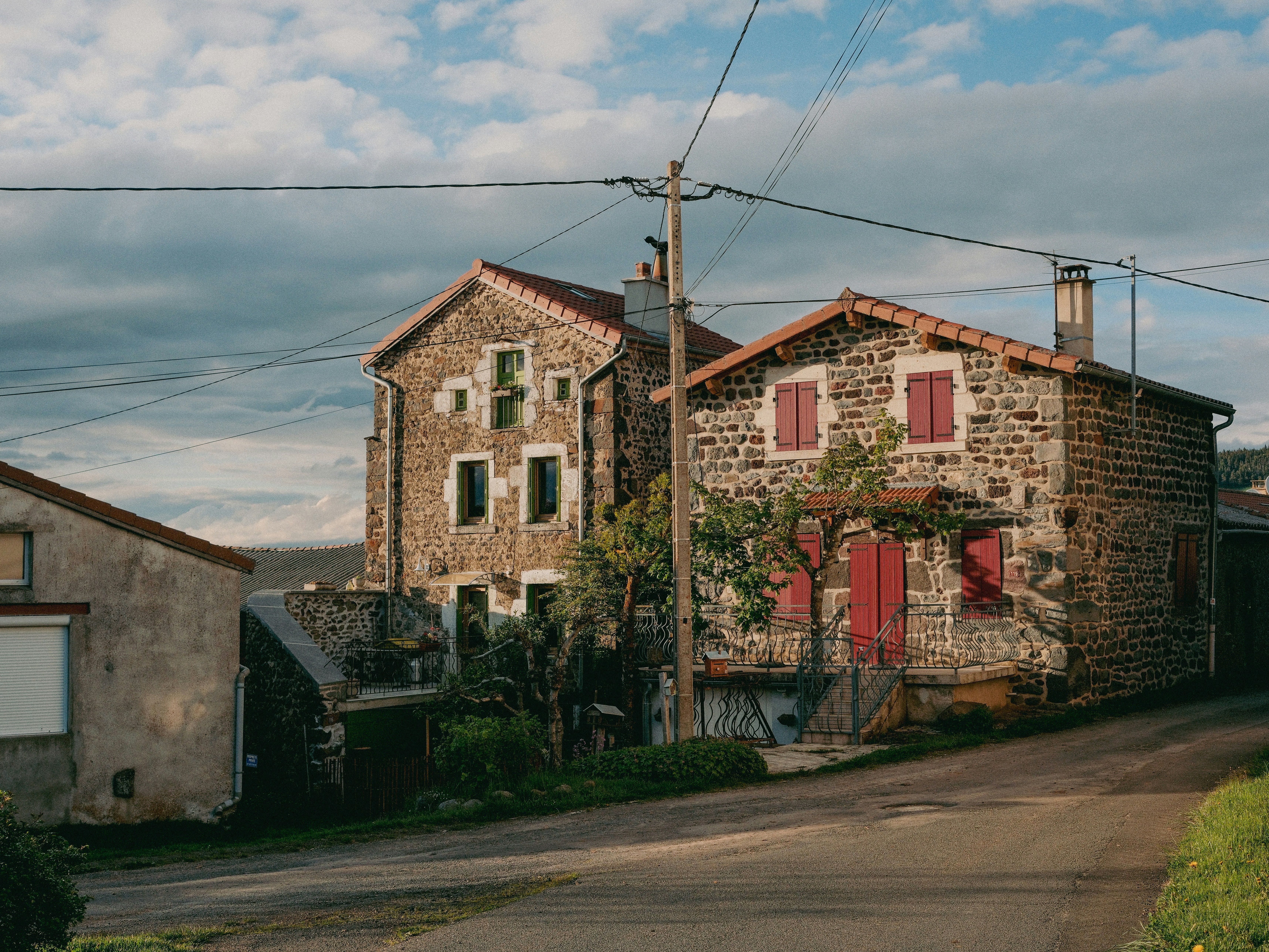 Stone House Summit: A Quiet Village Corner Under Wide Sky