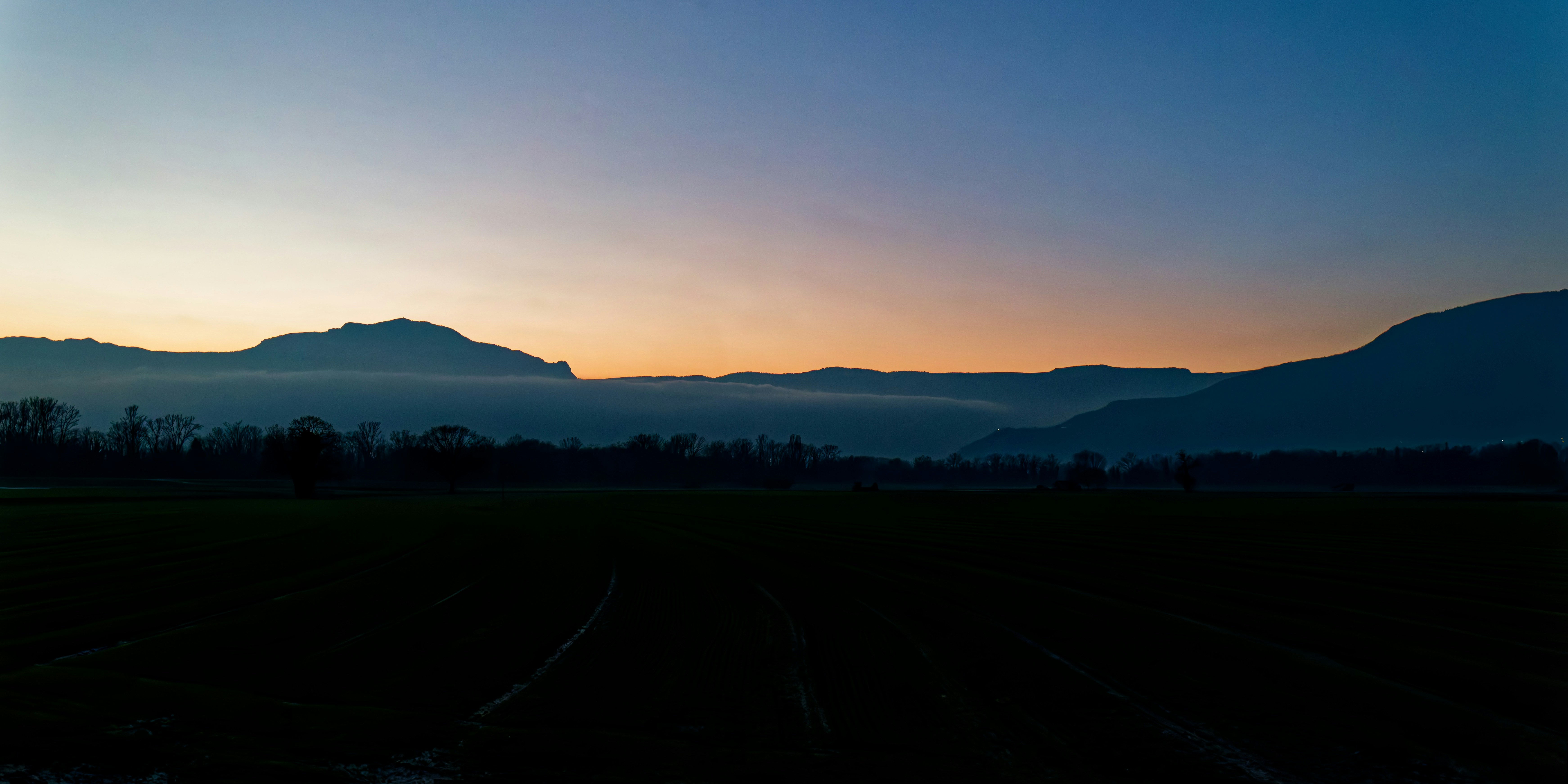 Dawn Over Quiet Valleys: A Valley’s Silhouette at the Horizon
