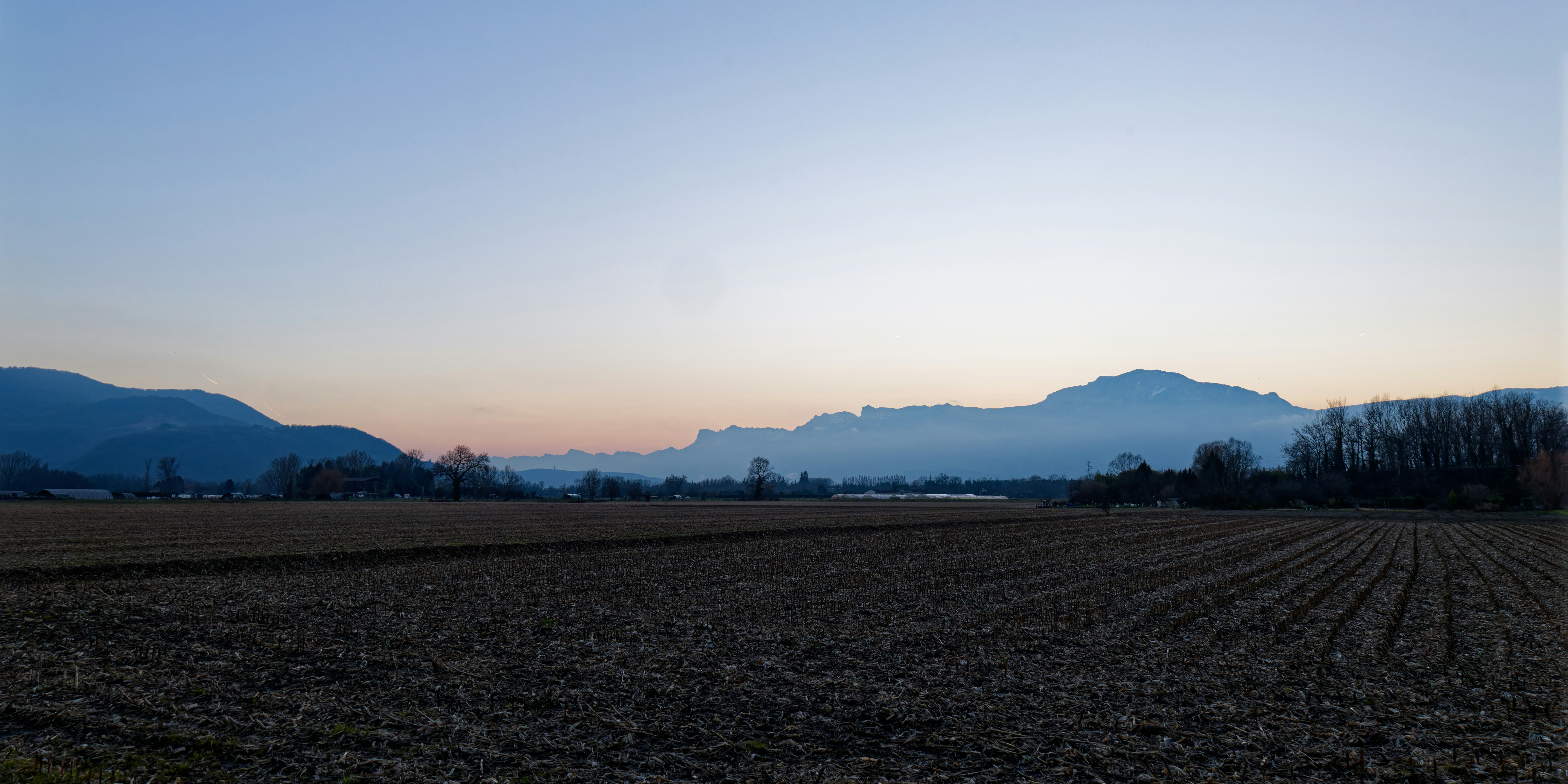 Twilight Ridge Over a Quiet Farmland