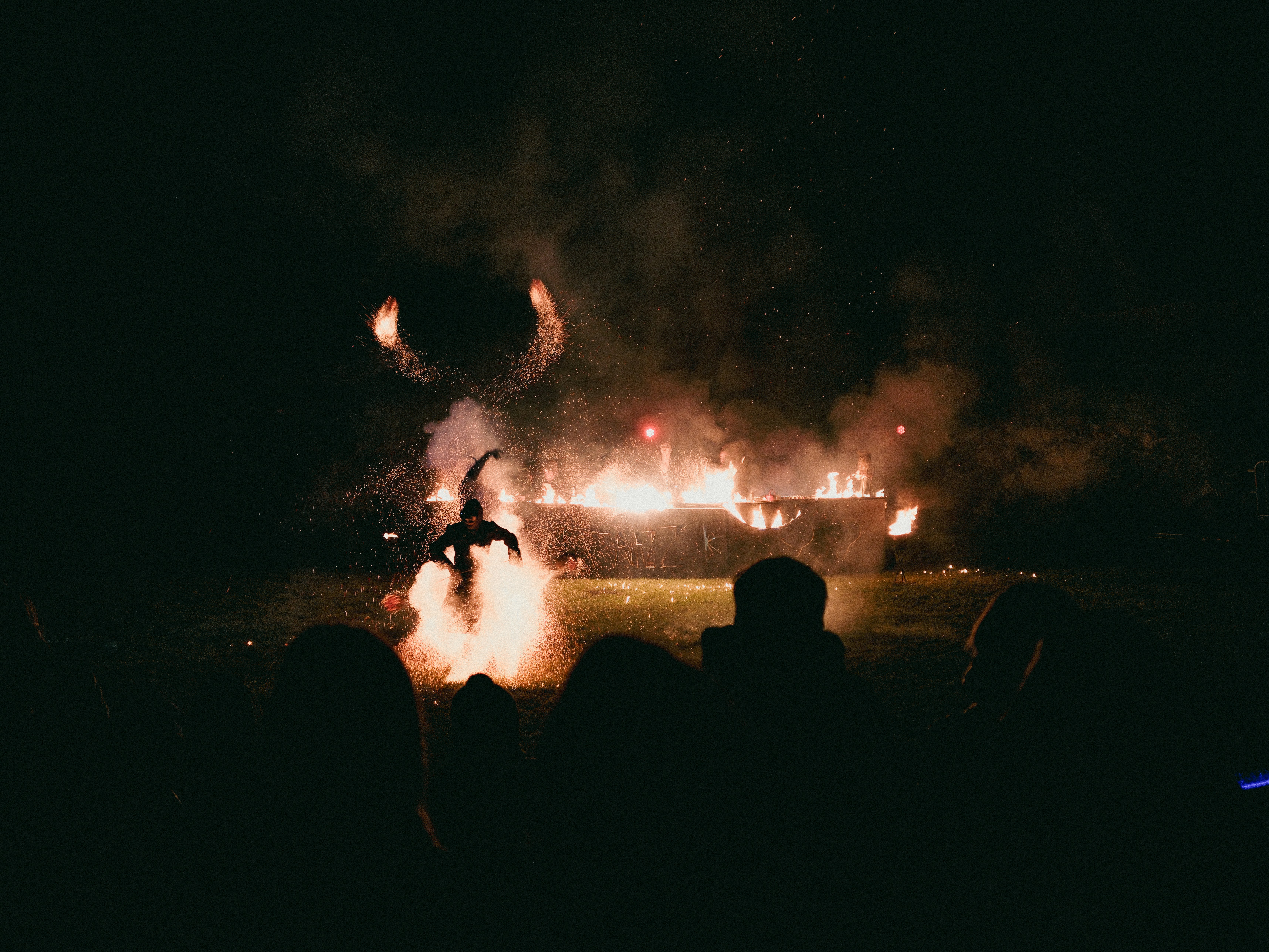 Night Spectacle: Fire, Smoke, and silhouettes on a distant field