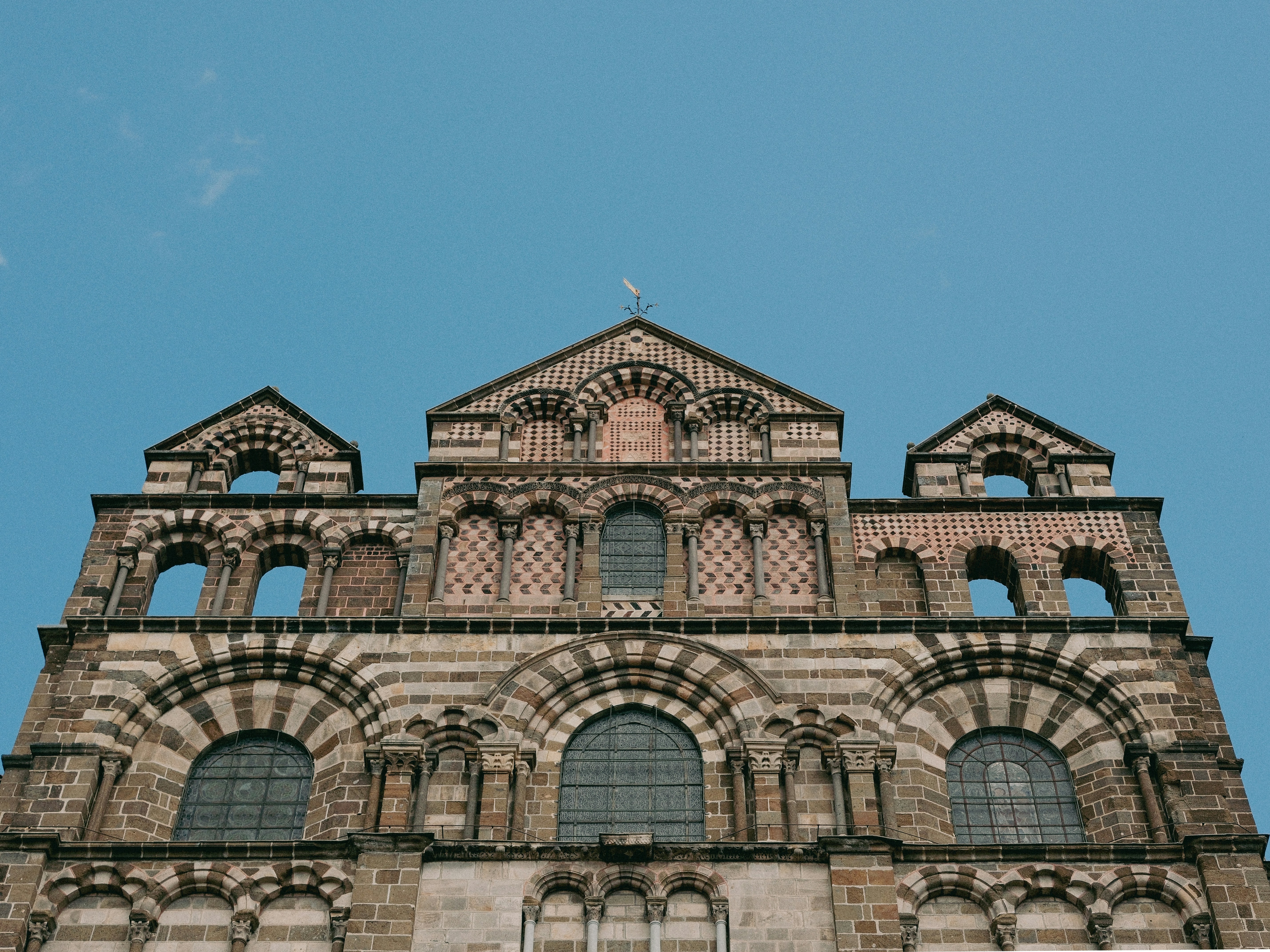 Architectural Symmetry: A Romanesque Facade Reaching Toward the Sky
