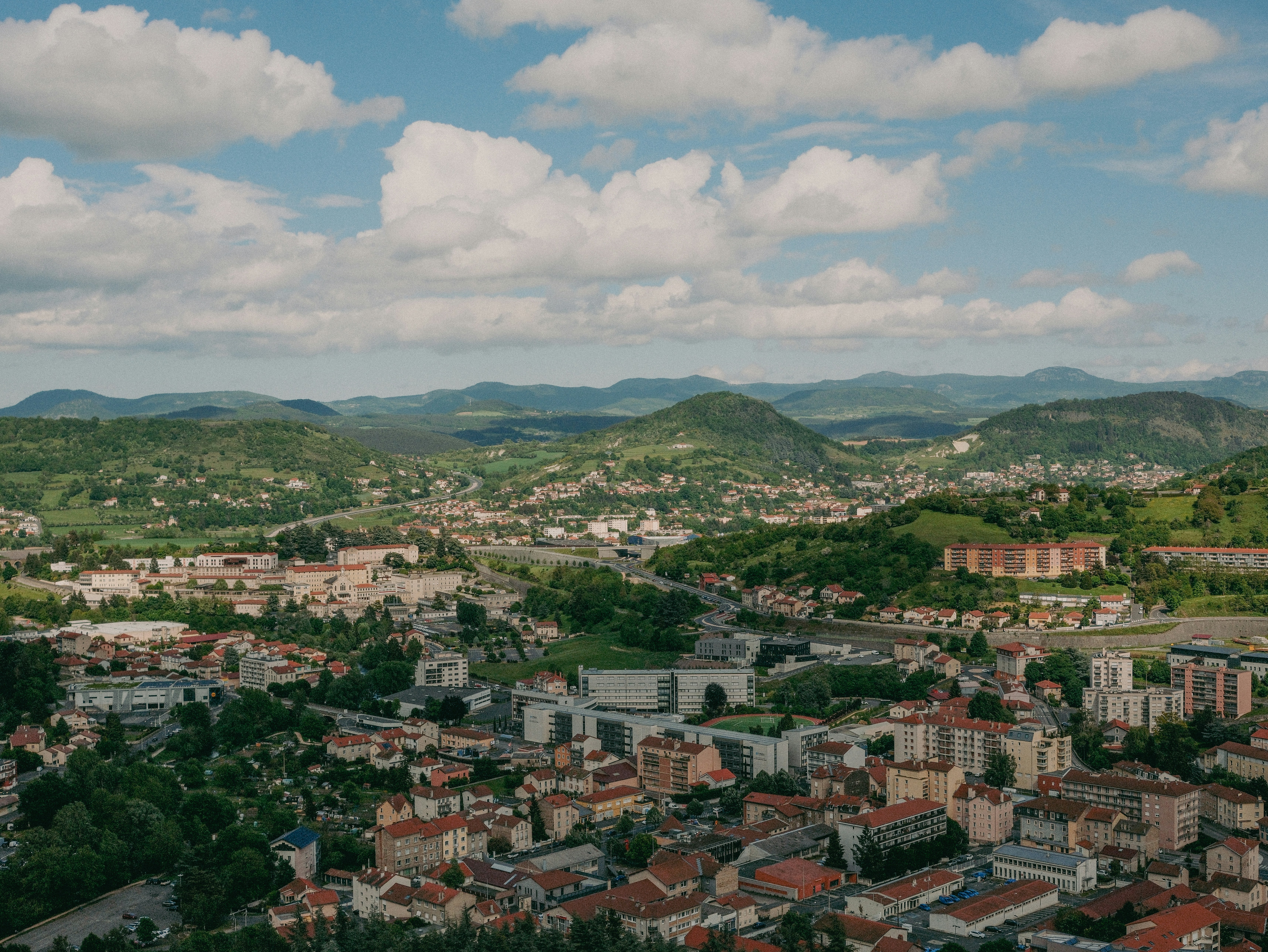 Aerial Panorama: Crescent hills embracing a mid-sized town