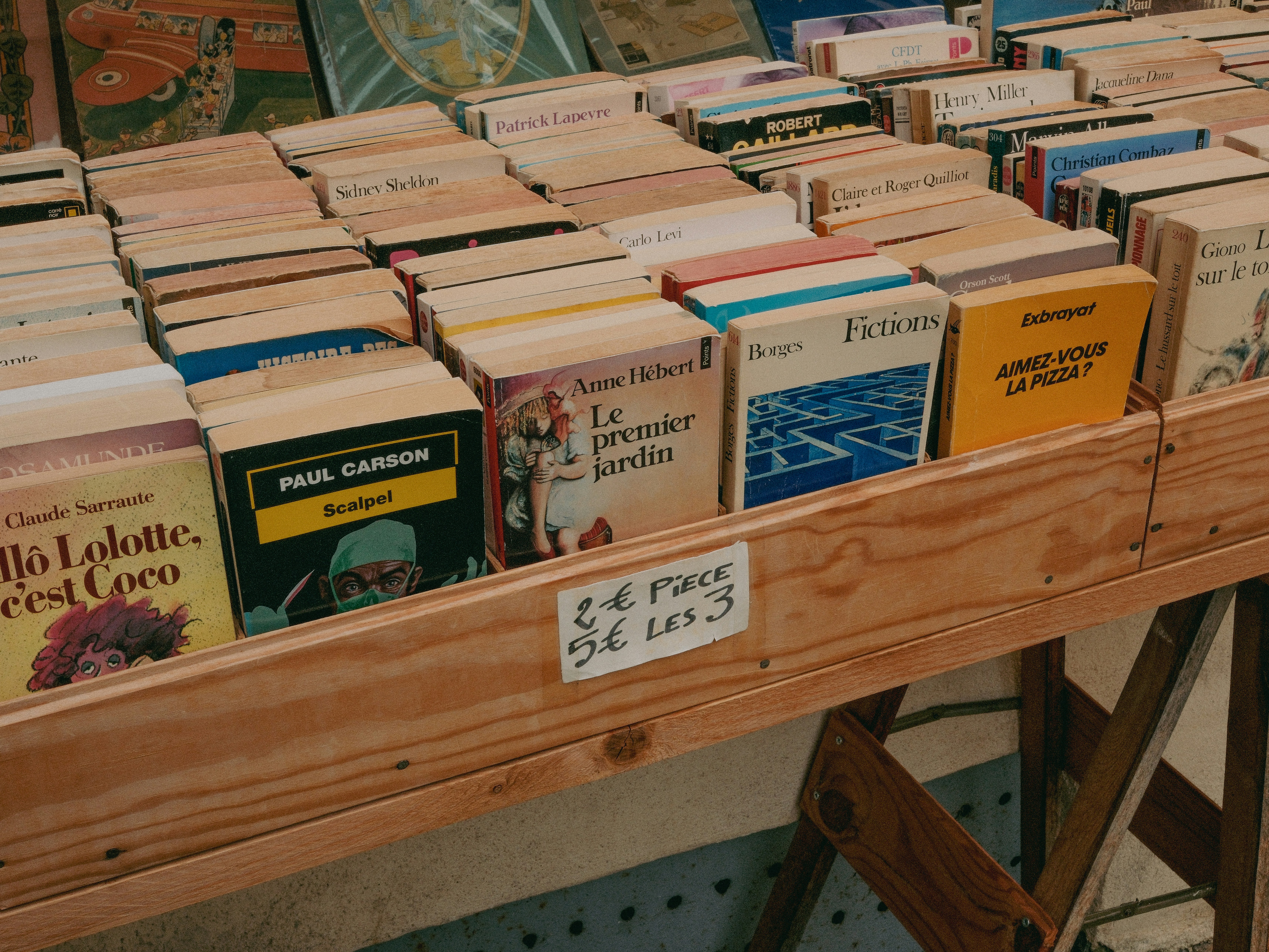 Row of Pocket Novels on a Warm Wooden Book Cart