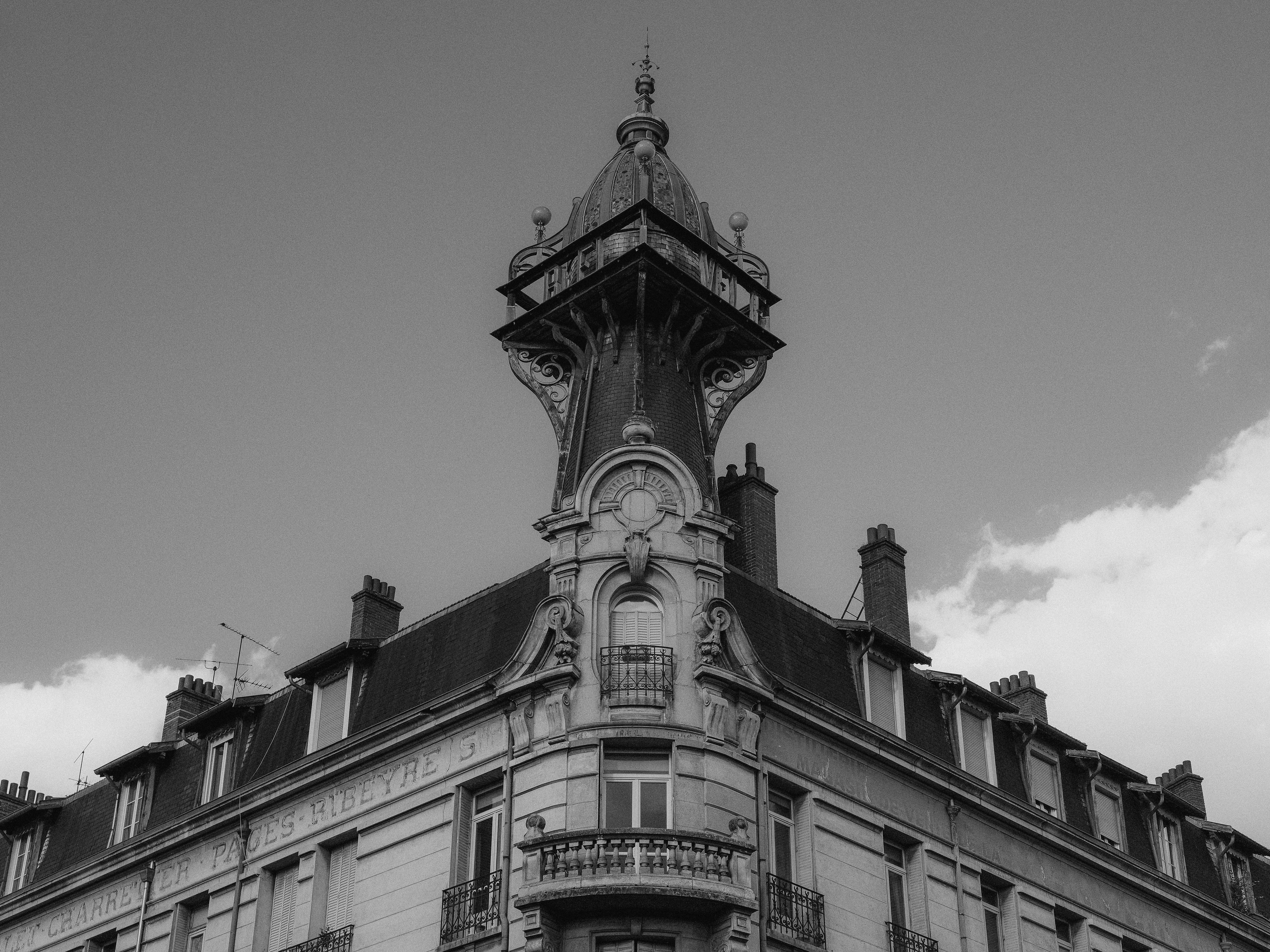 Ornate Corner Spire Crowned by a Facade Sentinel