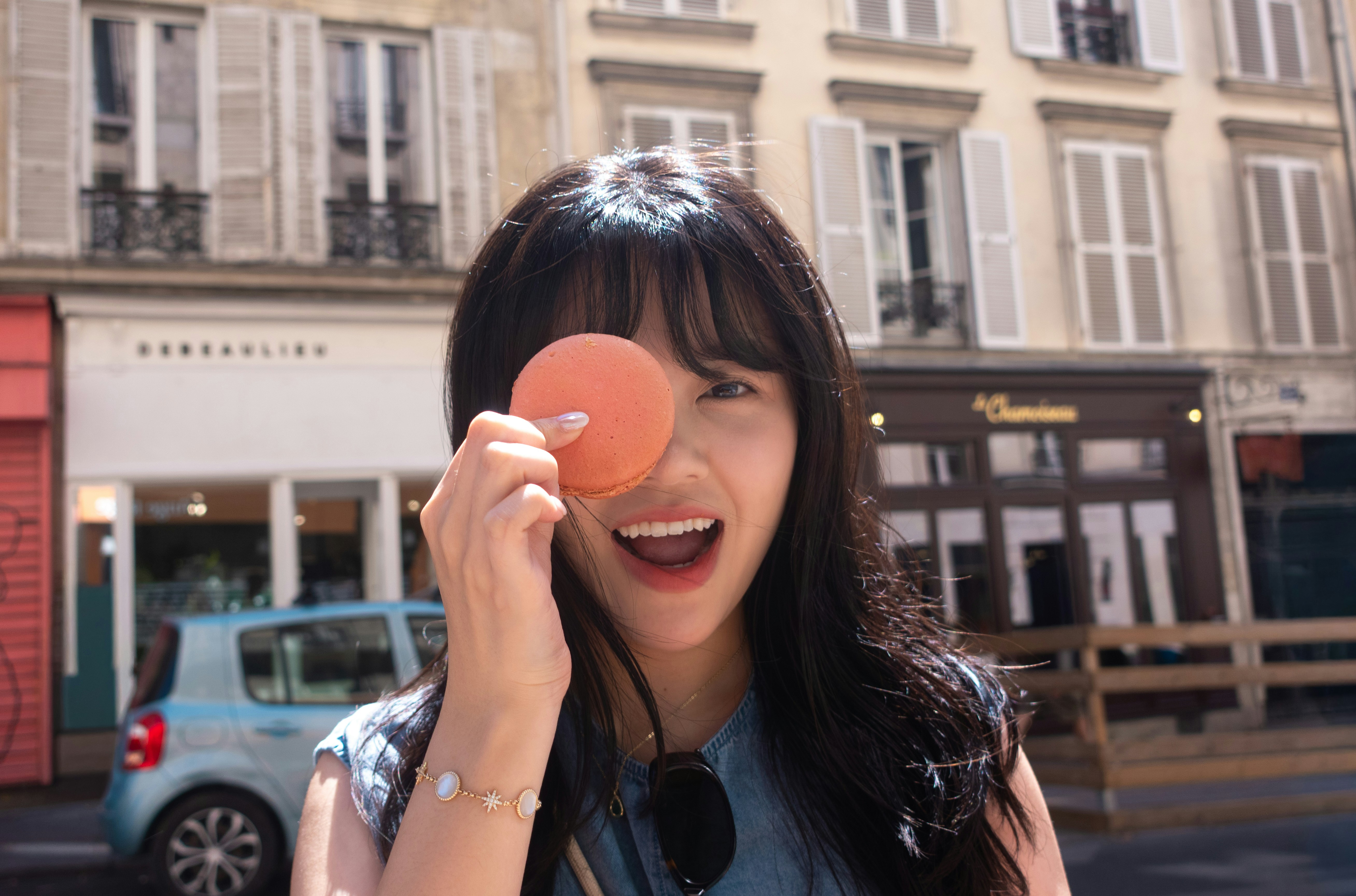 Sunlit Smile with a Rosy Accent: Street Portrait in Soft Focus