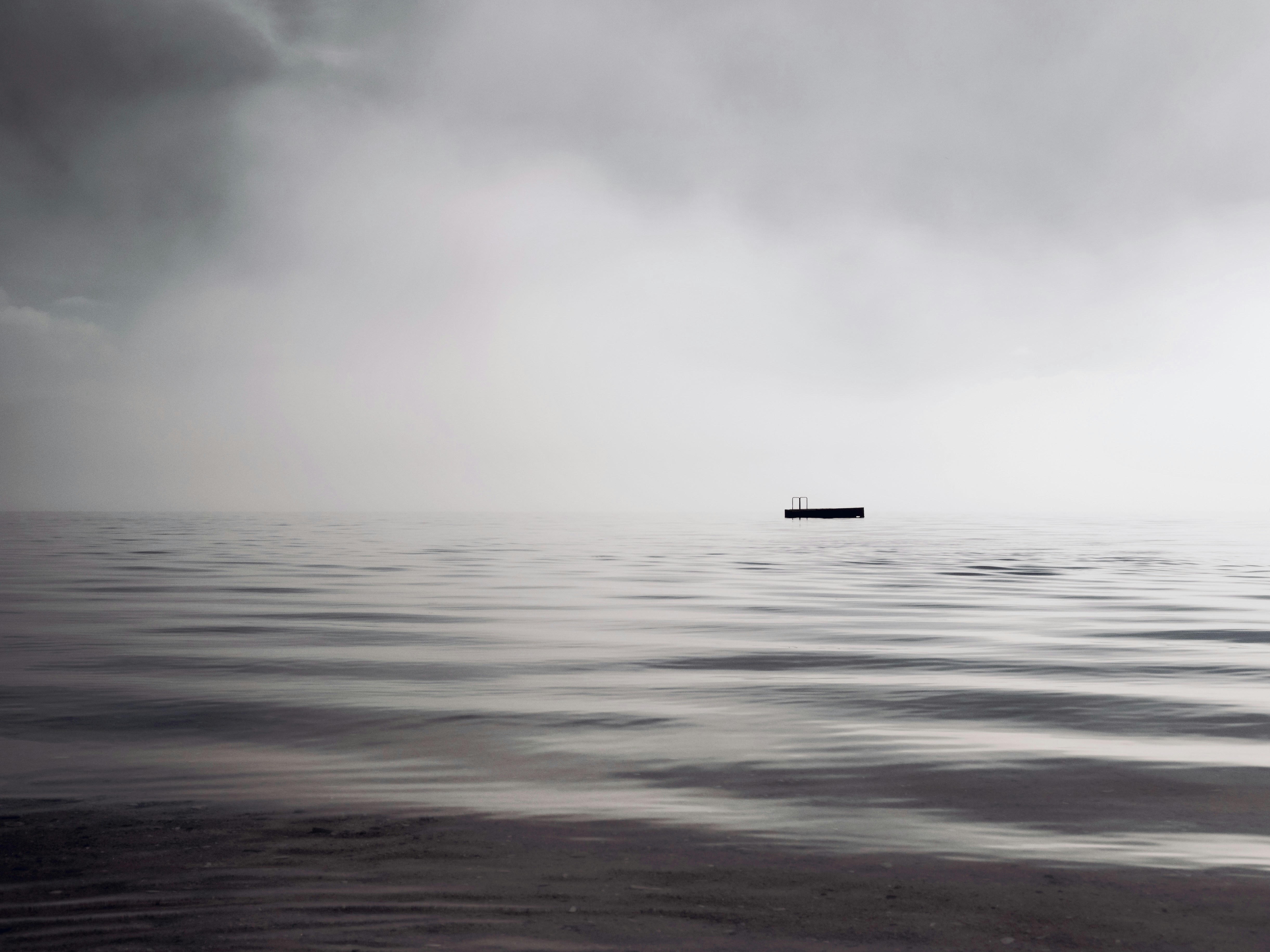 Solitary Boat on Mist-Softened Horizon