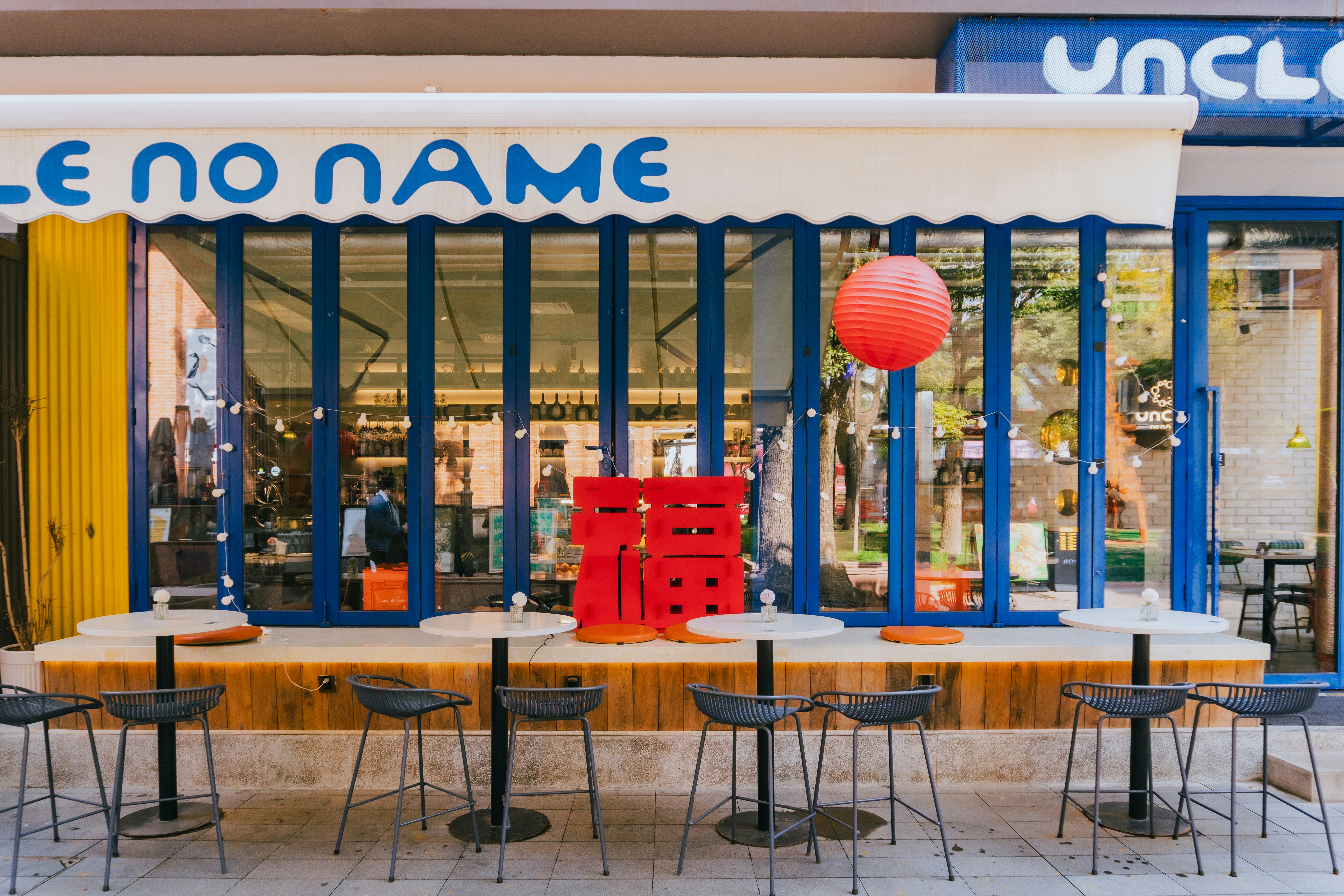 Red Lantern over a Blue-Frame Cafe Studio