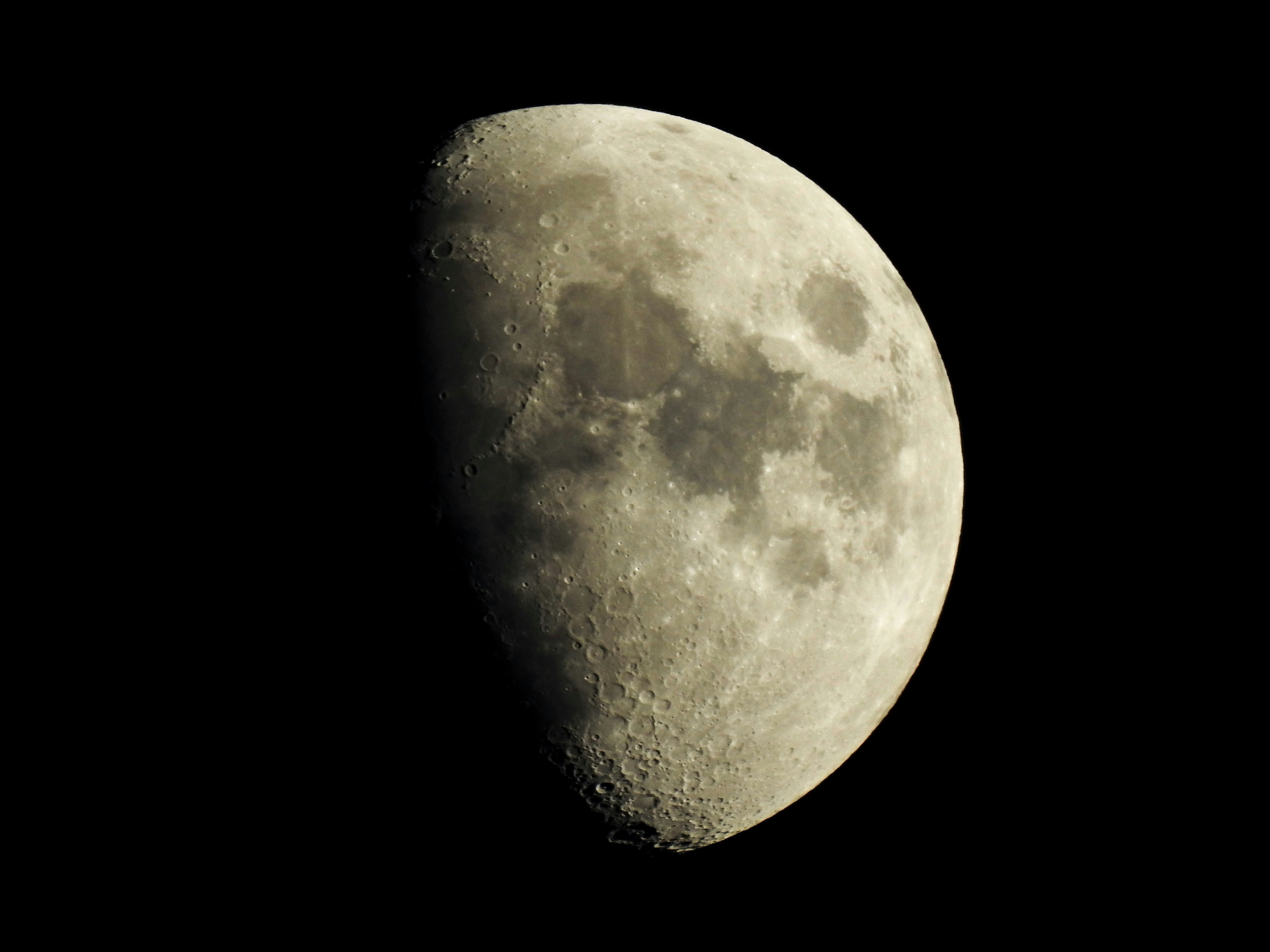 Bright lunar crescent with terminator detailing visible against a deep black sky.