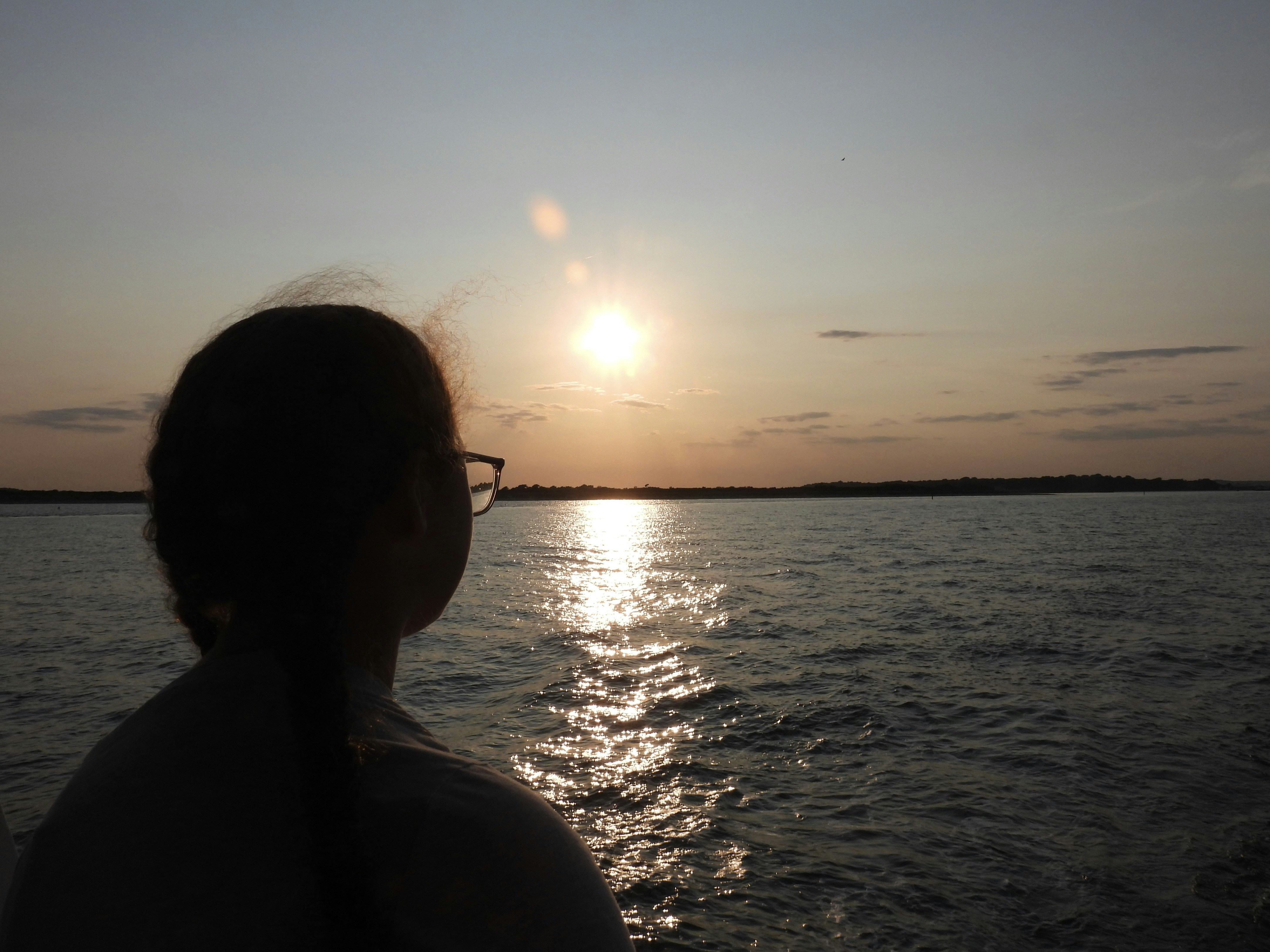 Sunset Silhouette Over Gentle Wake