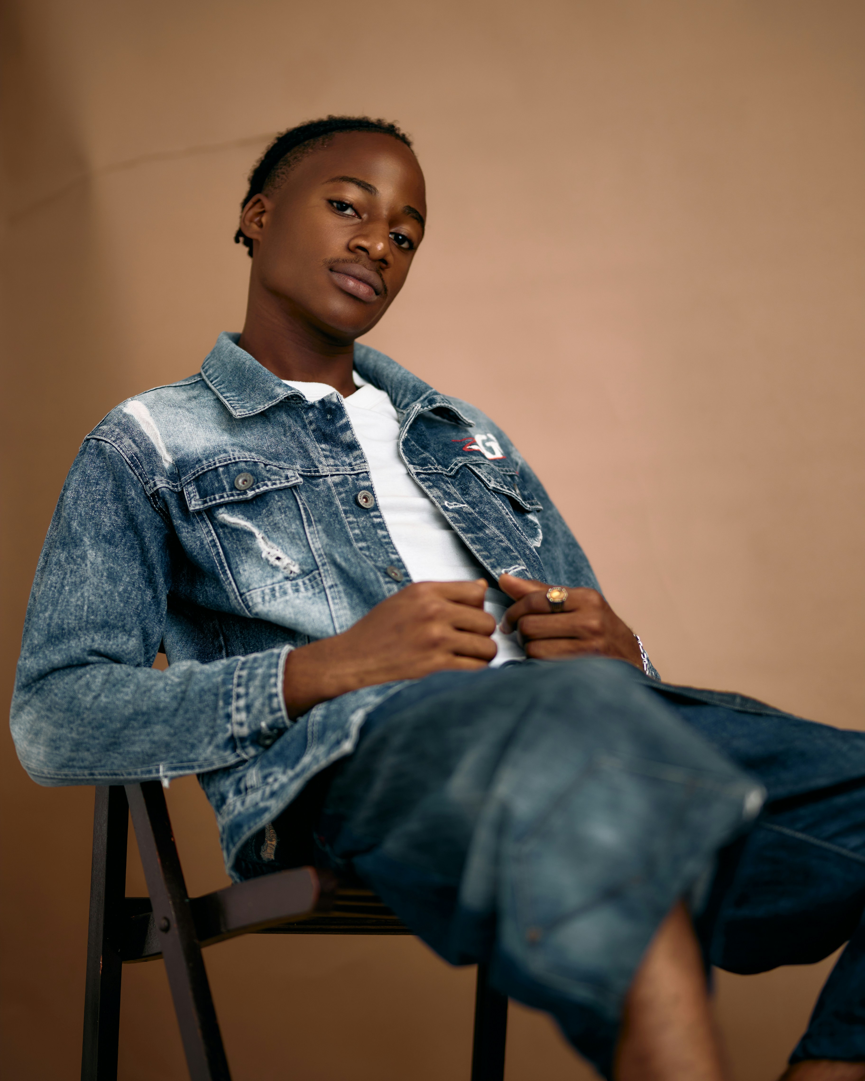 Relaxed Confidence: A Portrait in Warm Studio Tones