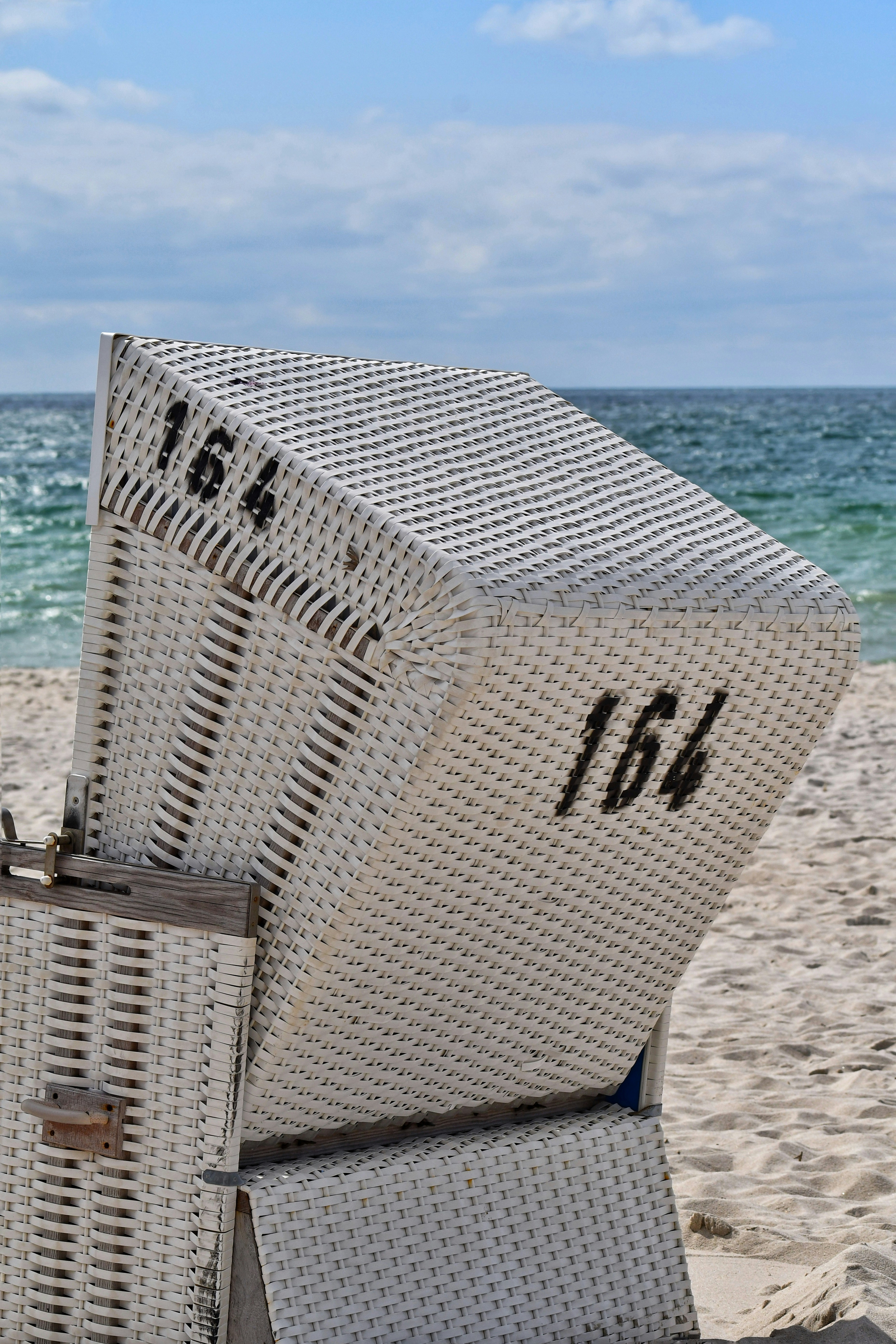 Beach Stand: A Weathered Lifeguard Chair Basking in Sunlit Shoreline