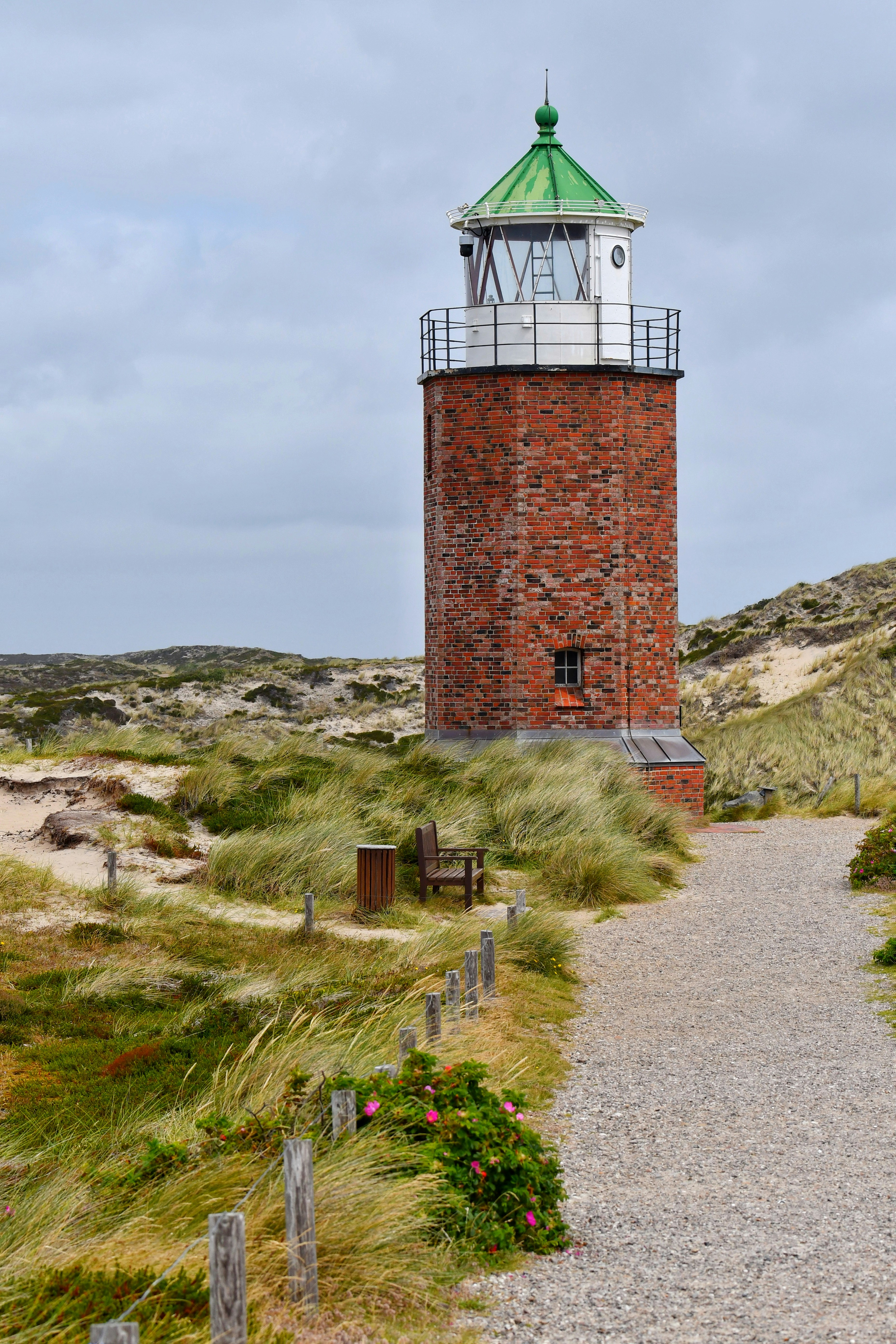 Lighthouse on the dune-spiked path