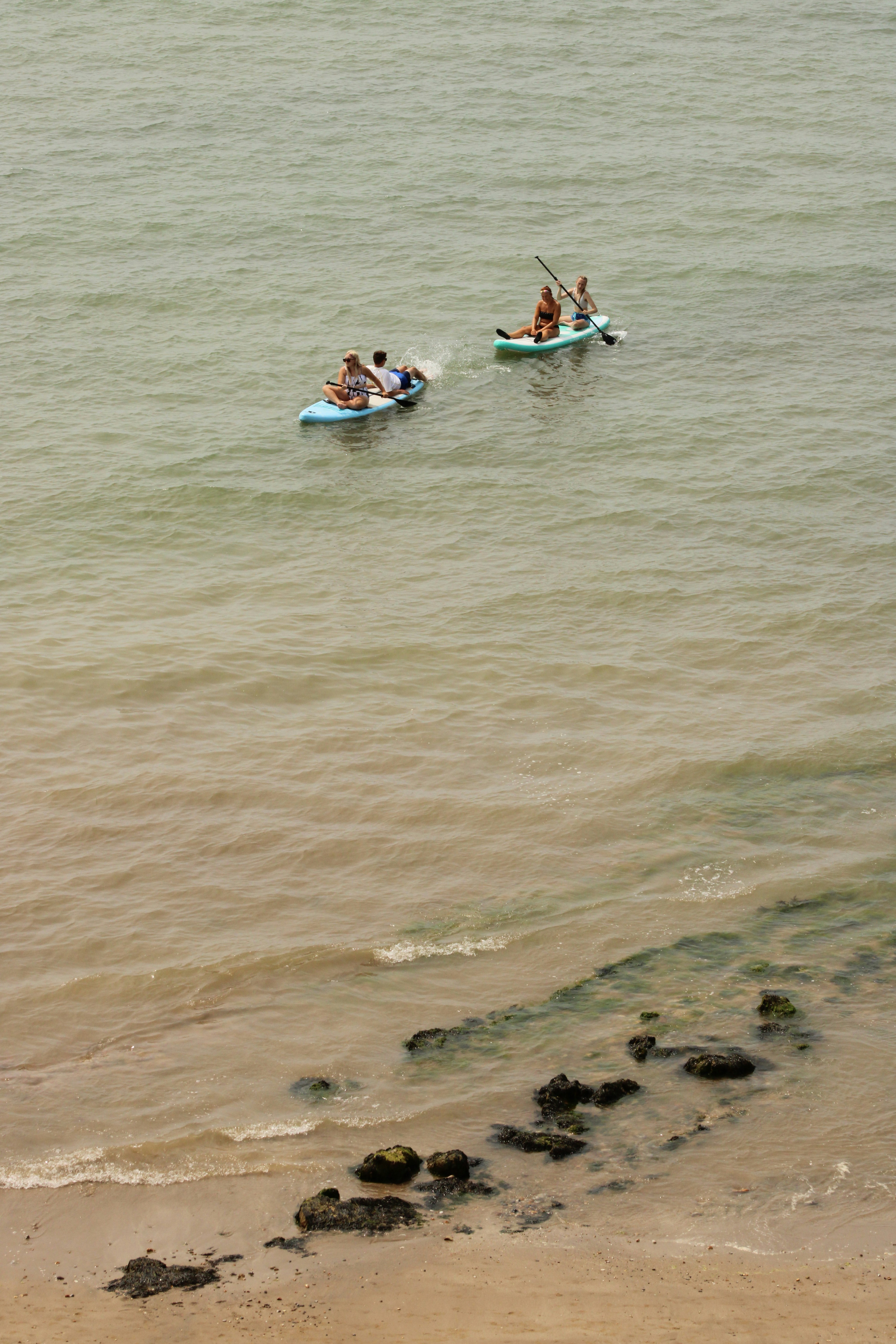 Three Kayaks Drift in Quiet Coastal Waters