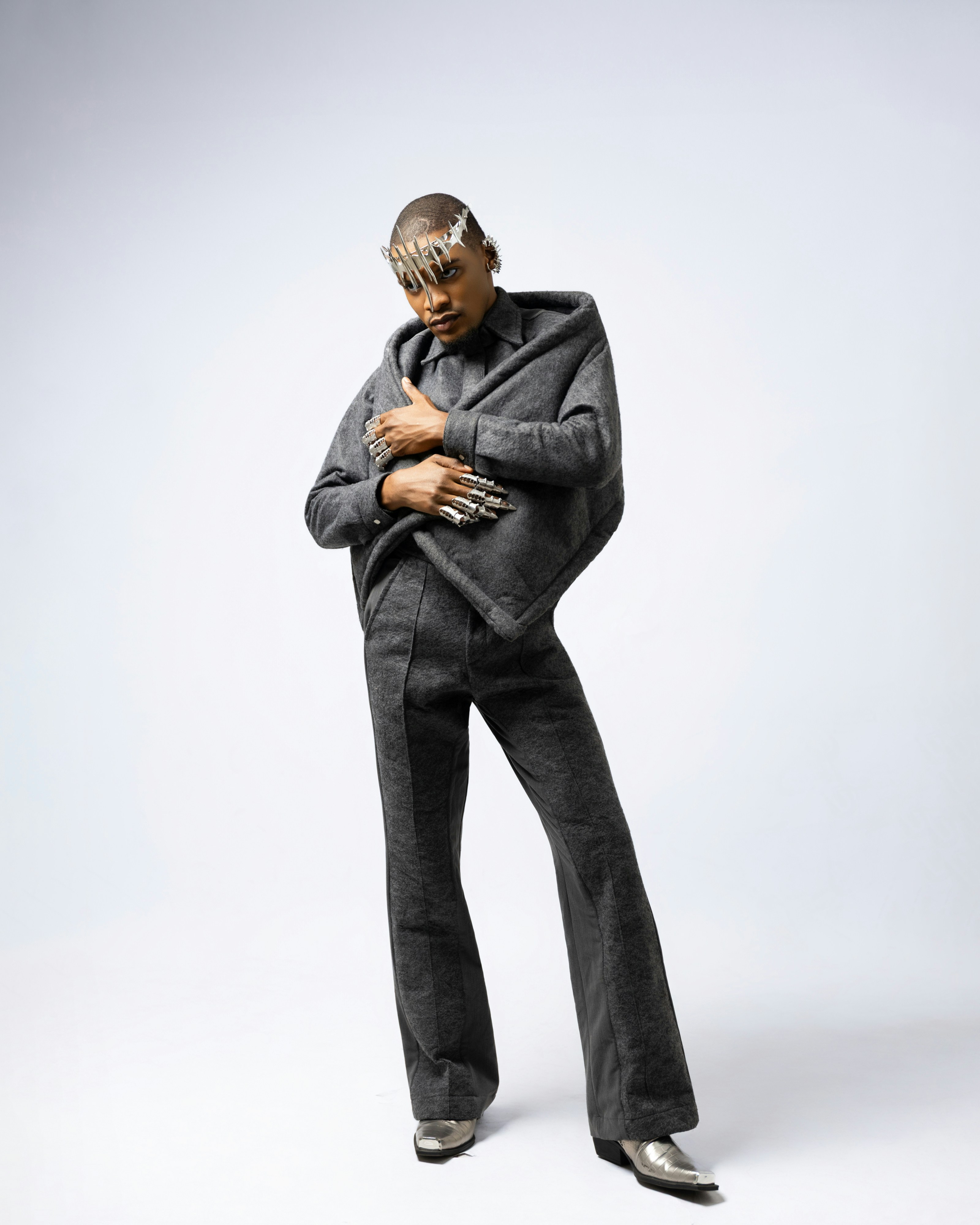 Shadowed Couture: A Poised Pose in Charcoal Layers