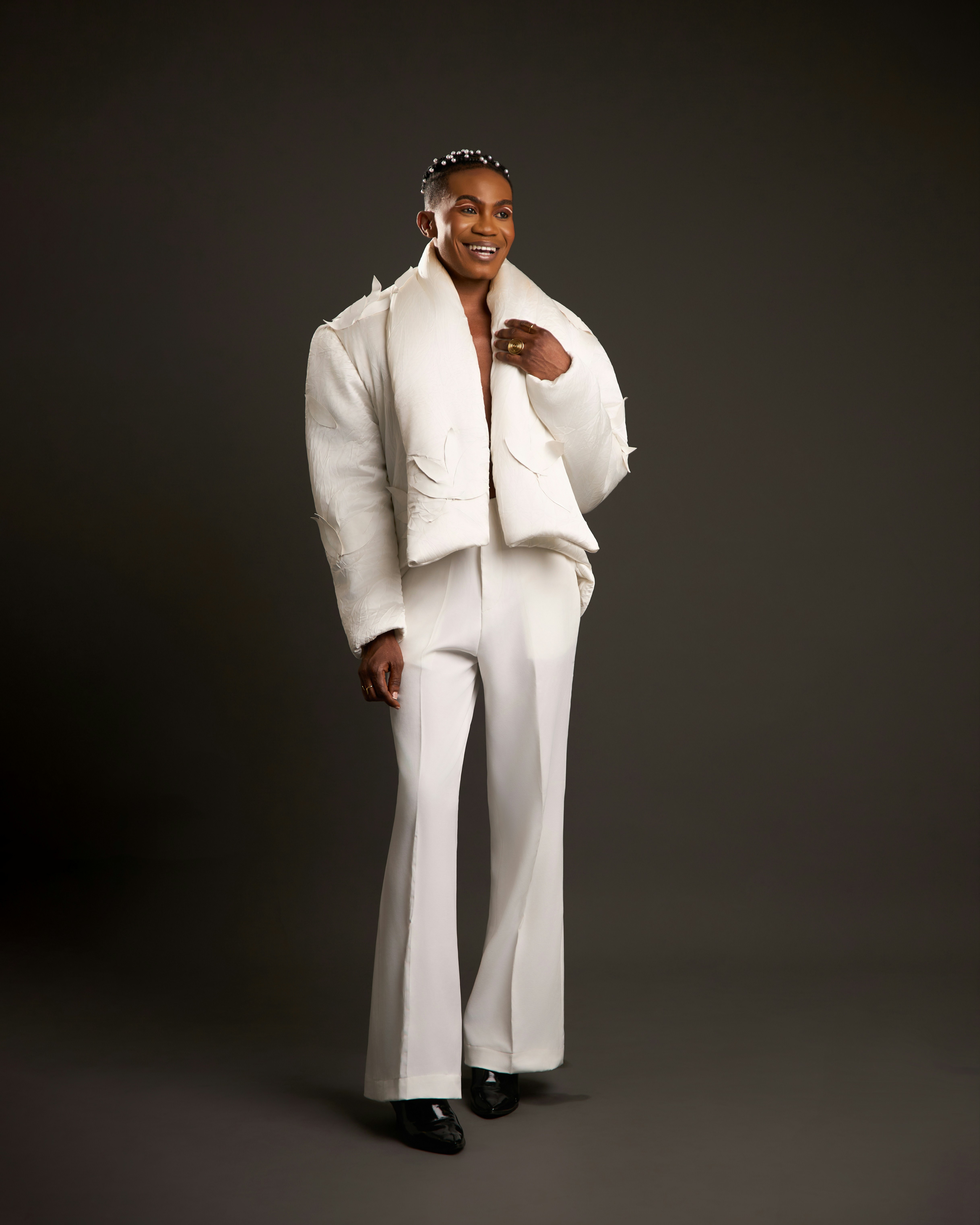 White Couture: A Confident Pose in an All-White Ensemble