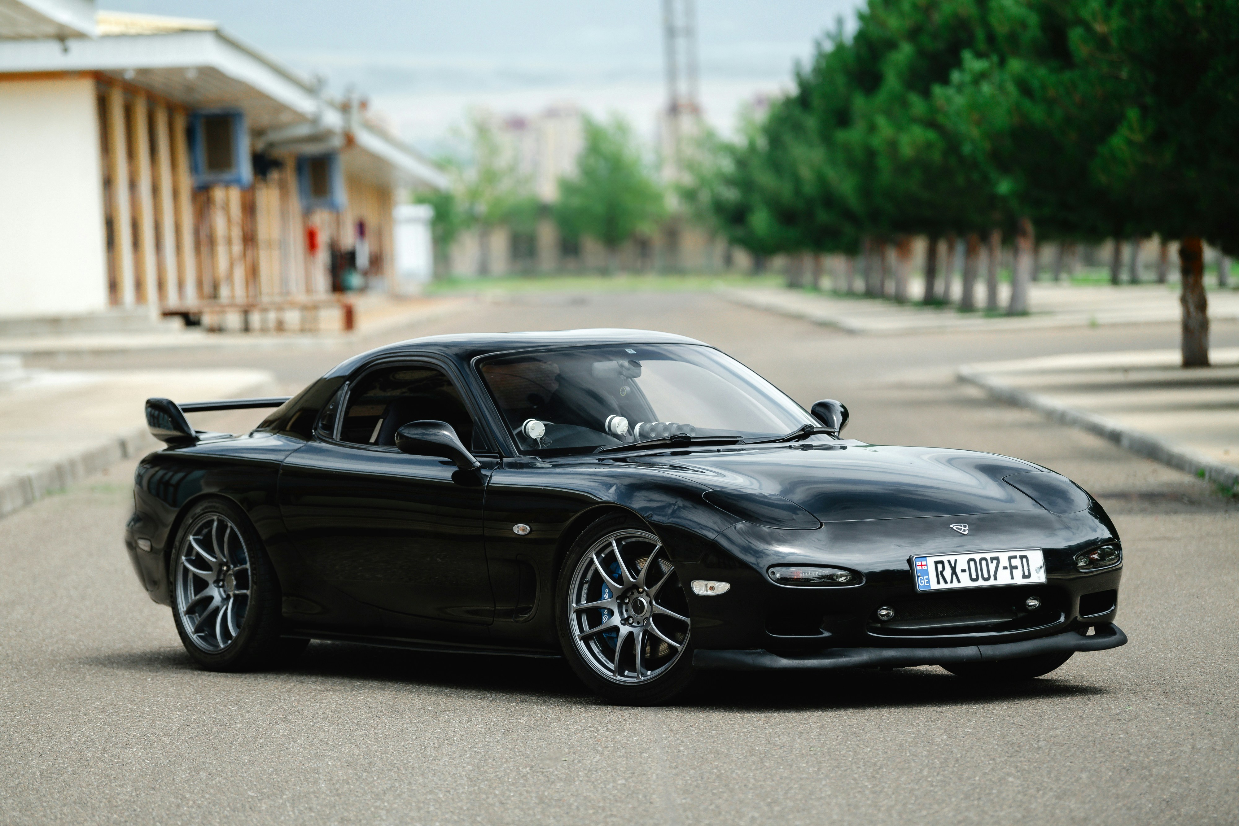 Midnight Gesture: A Sleek Black Sports Coupe Anchored by City Silence
