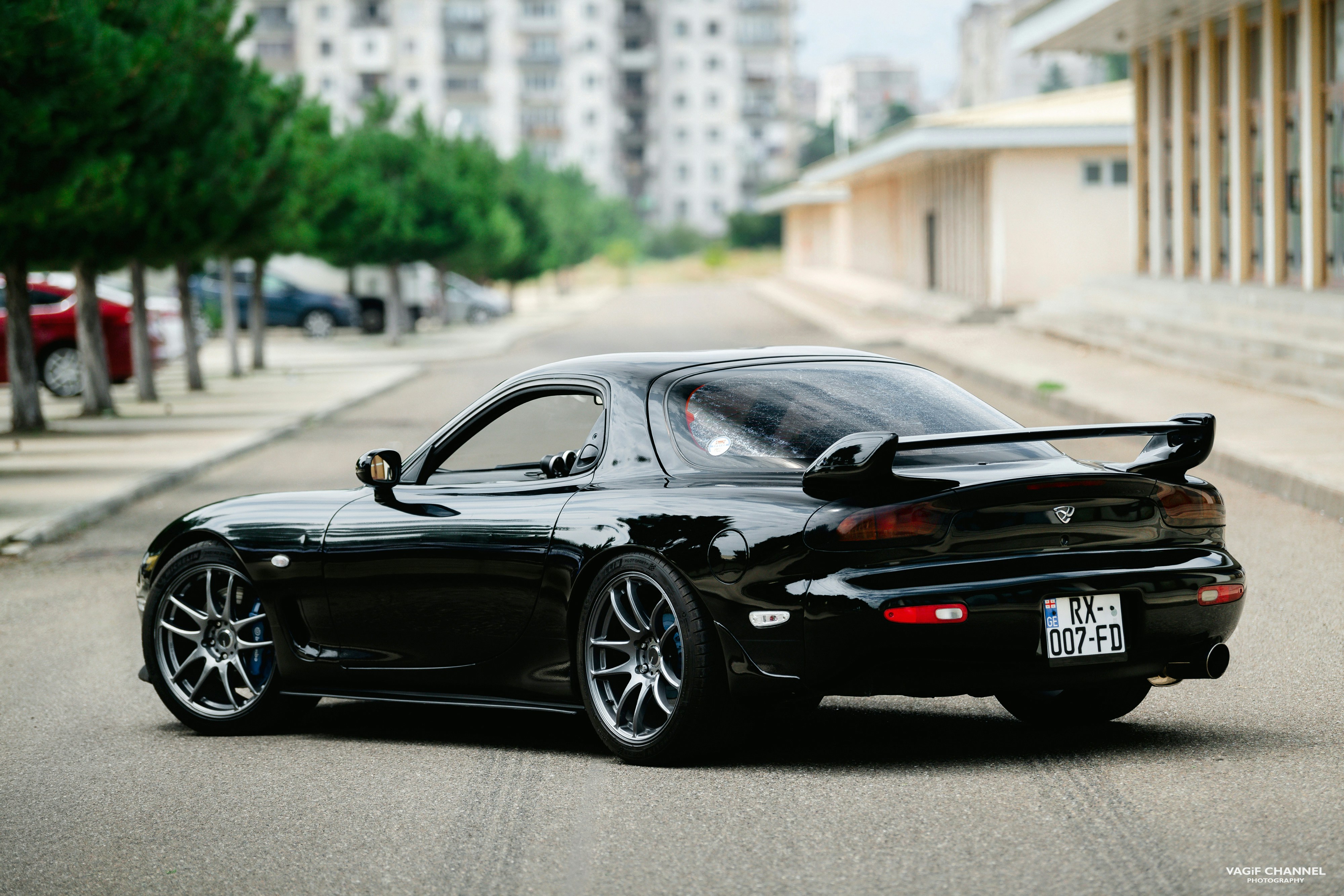 Midnight Thunder: A Black Mazda RX-7 Resting on an Empty Street