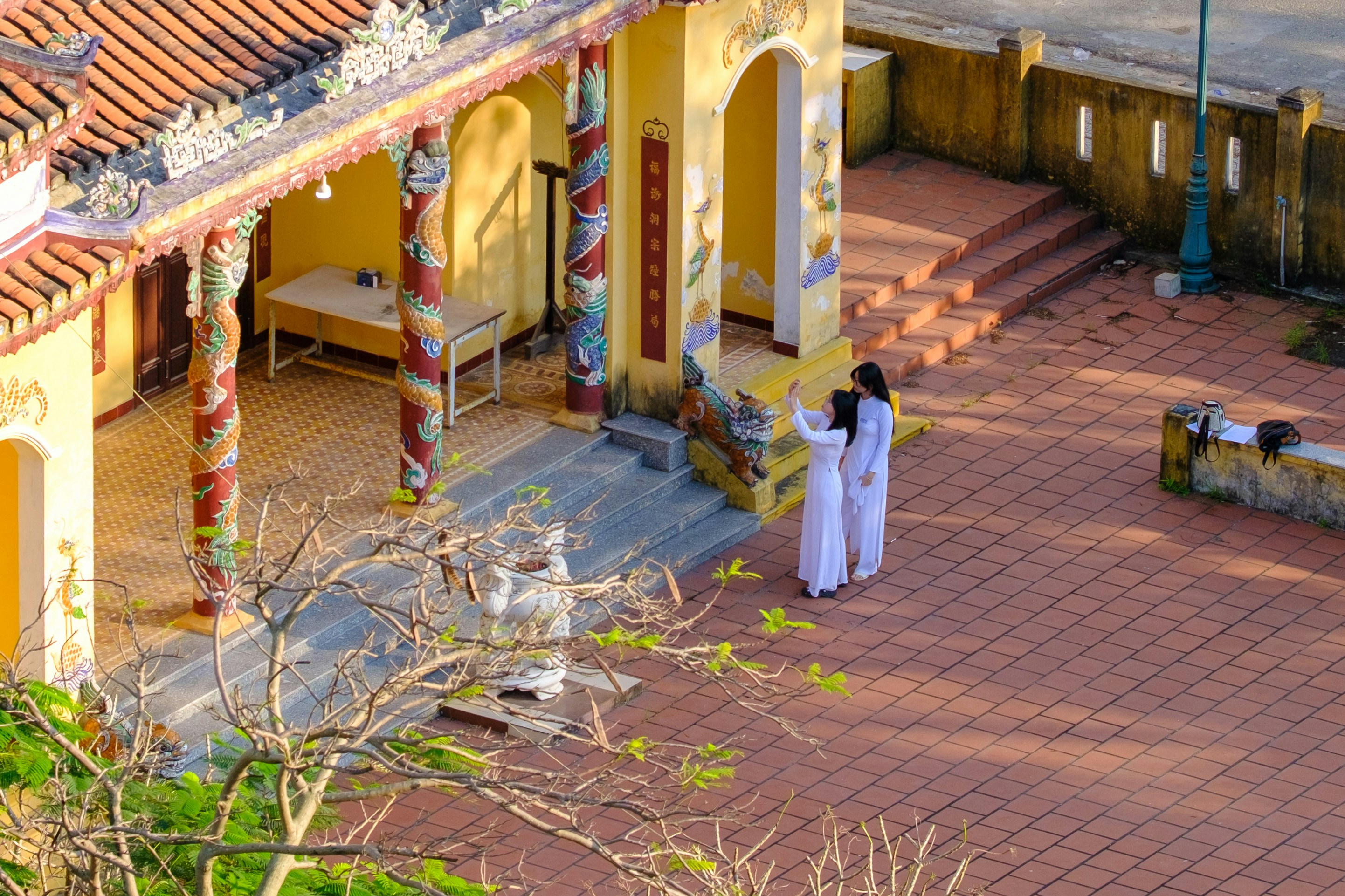 Hands Raised at the Lantern-Decorated Courtyard
