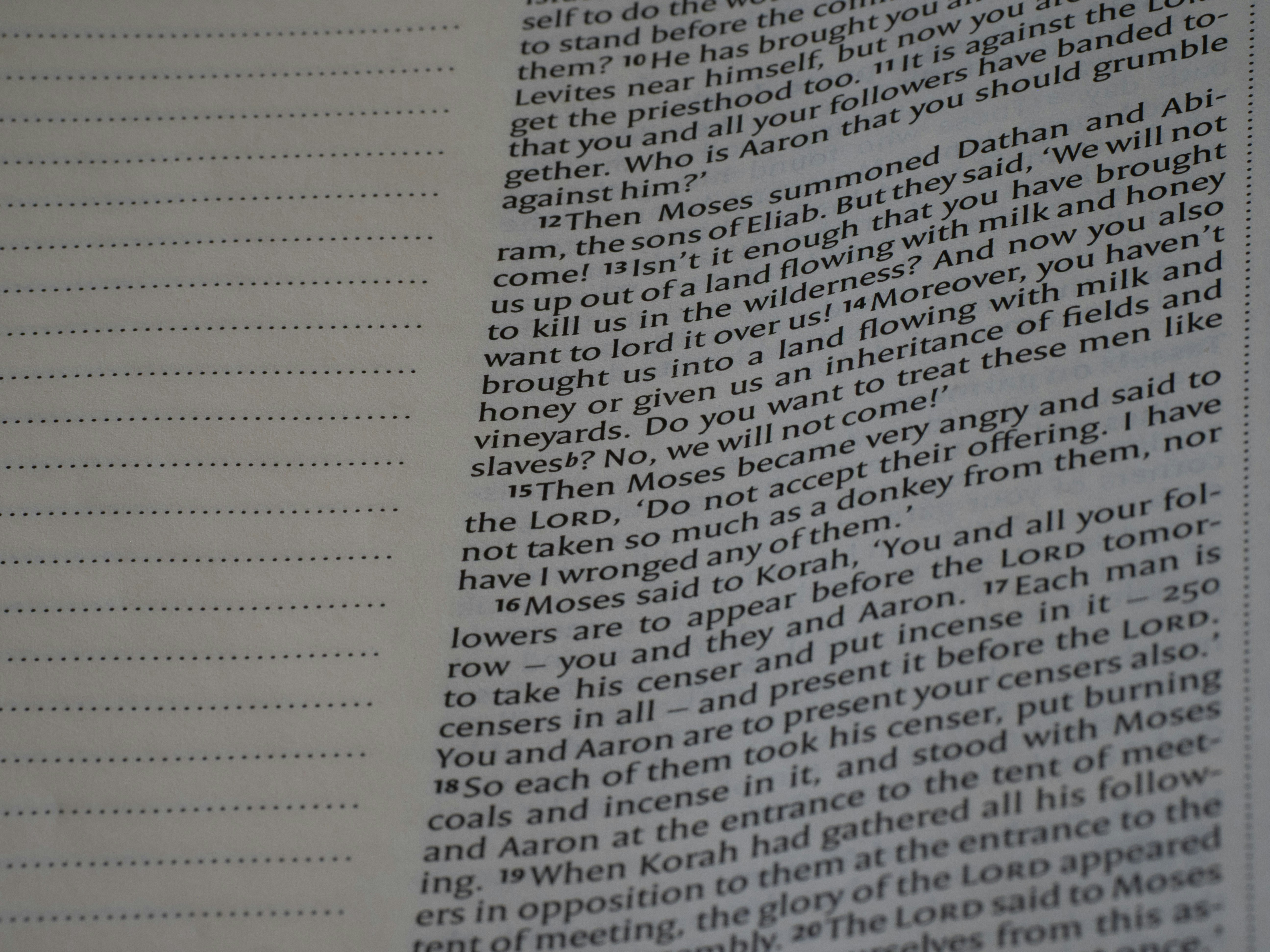 Close-up of printed text on a page with a visible folded edge; a portion of multiple lines in a book or pamphlet. This is a photographic capture of printed typography and layout.