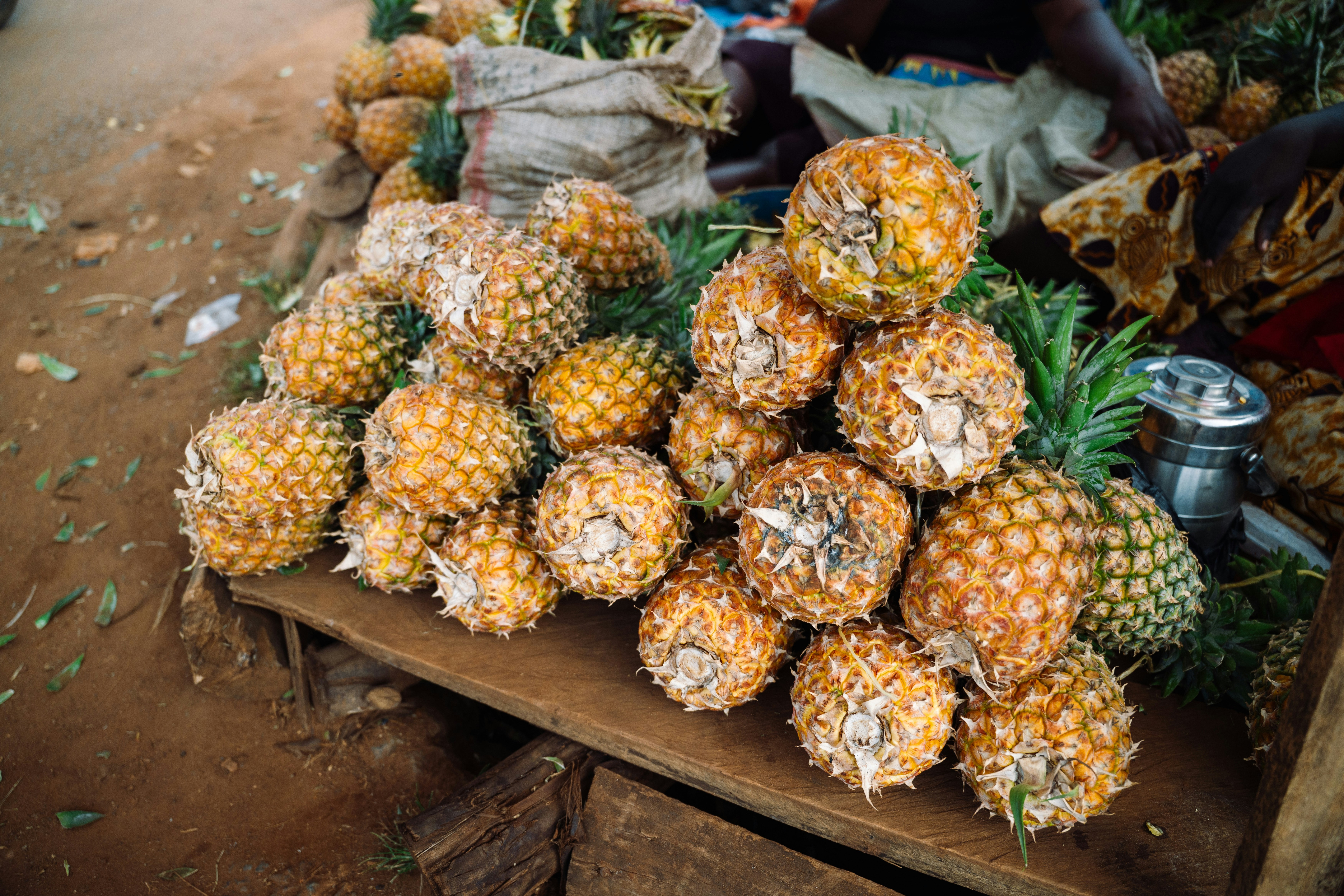 Pile of sun-kissed pineapples on a rustic market table