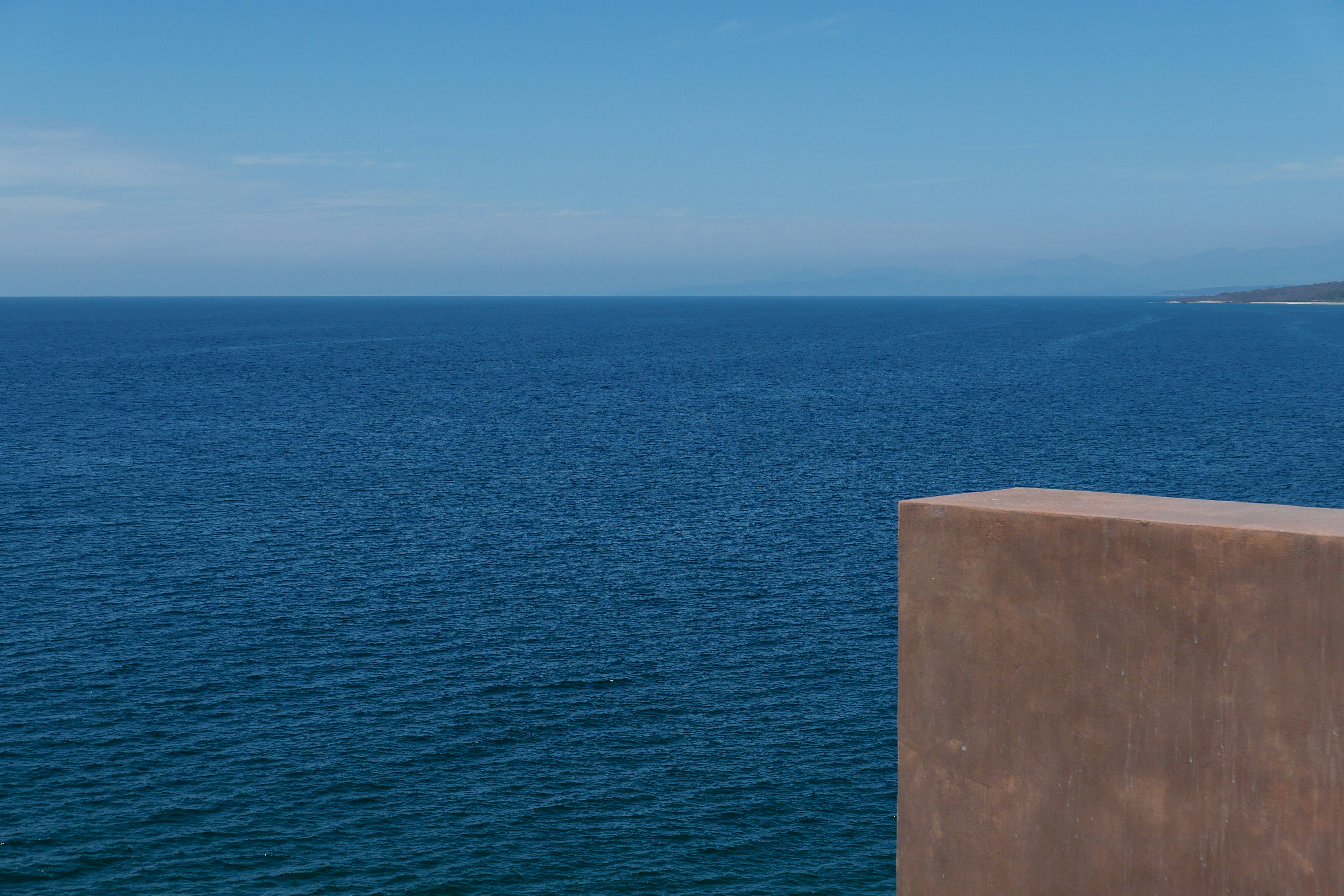 Coastal Edge: A Quiet Sea Meets Rusted Geometry