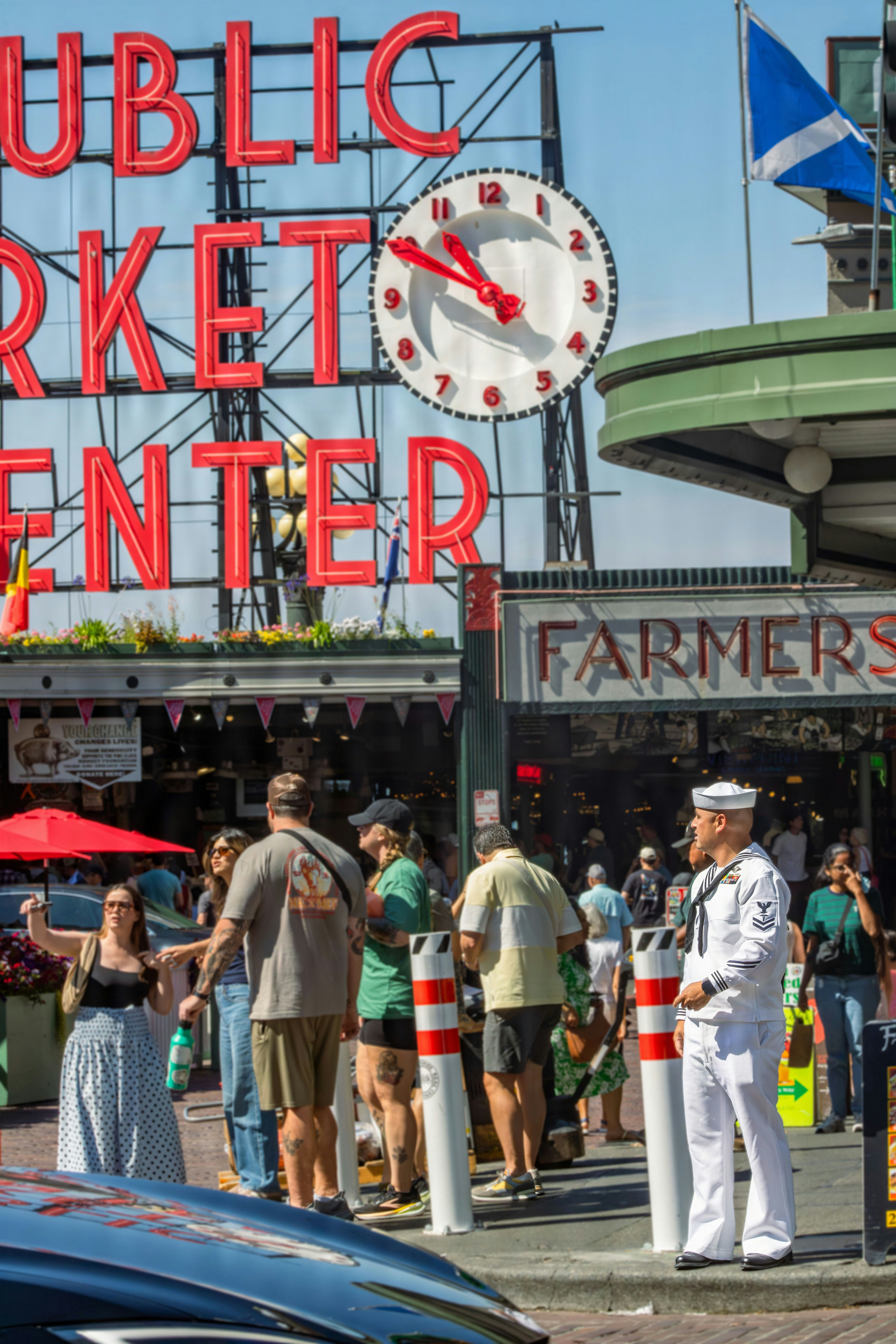 Clock Tower Entrance: A Bustling Market Scene Under Neon Signage
