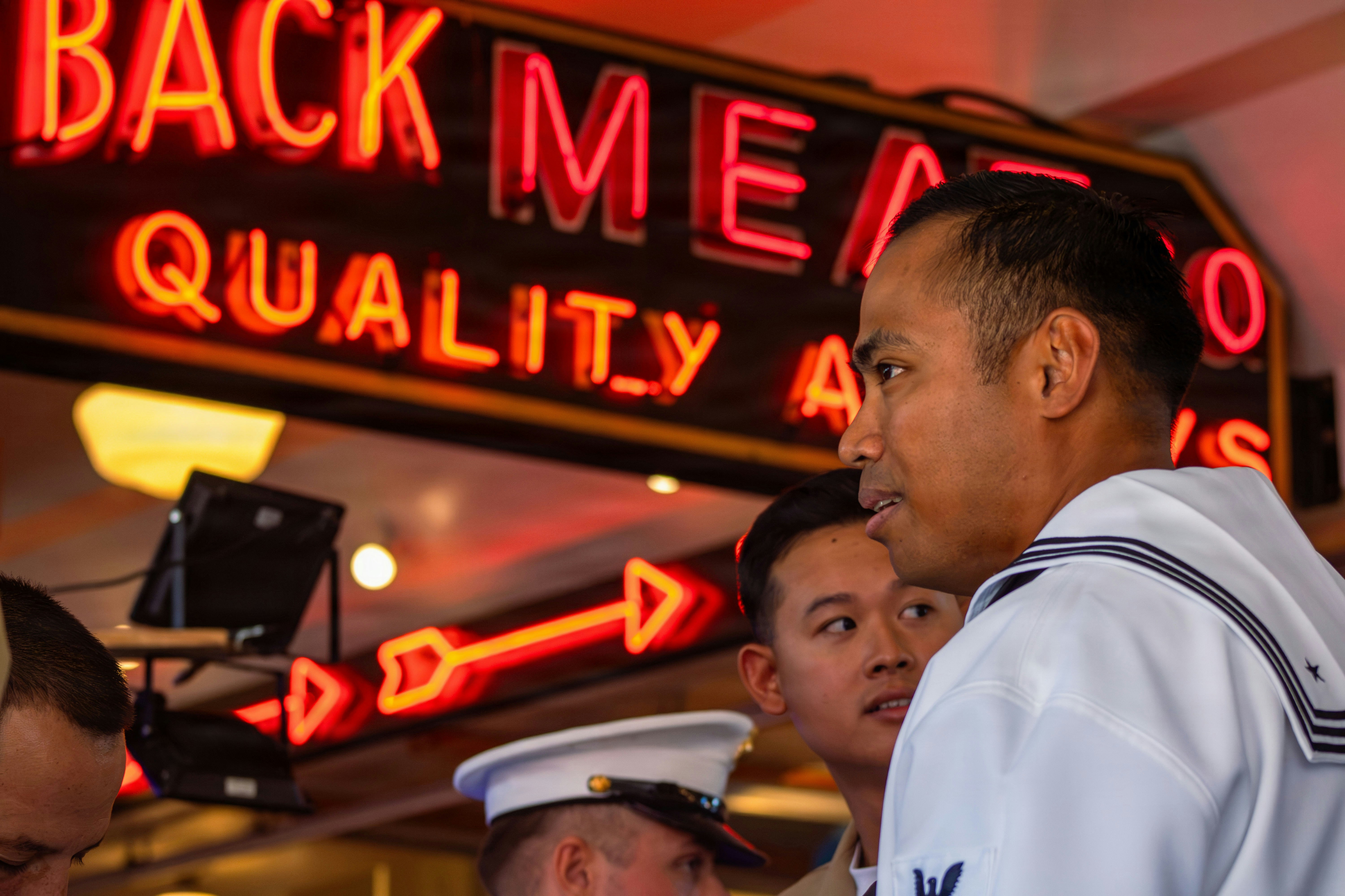 Neon-Backlit Exchange: A Marine Parley Amid City Lights