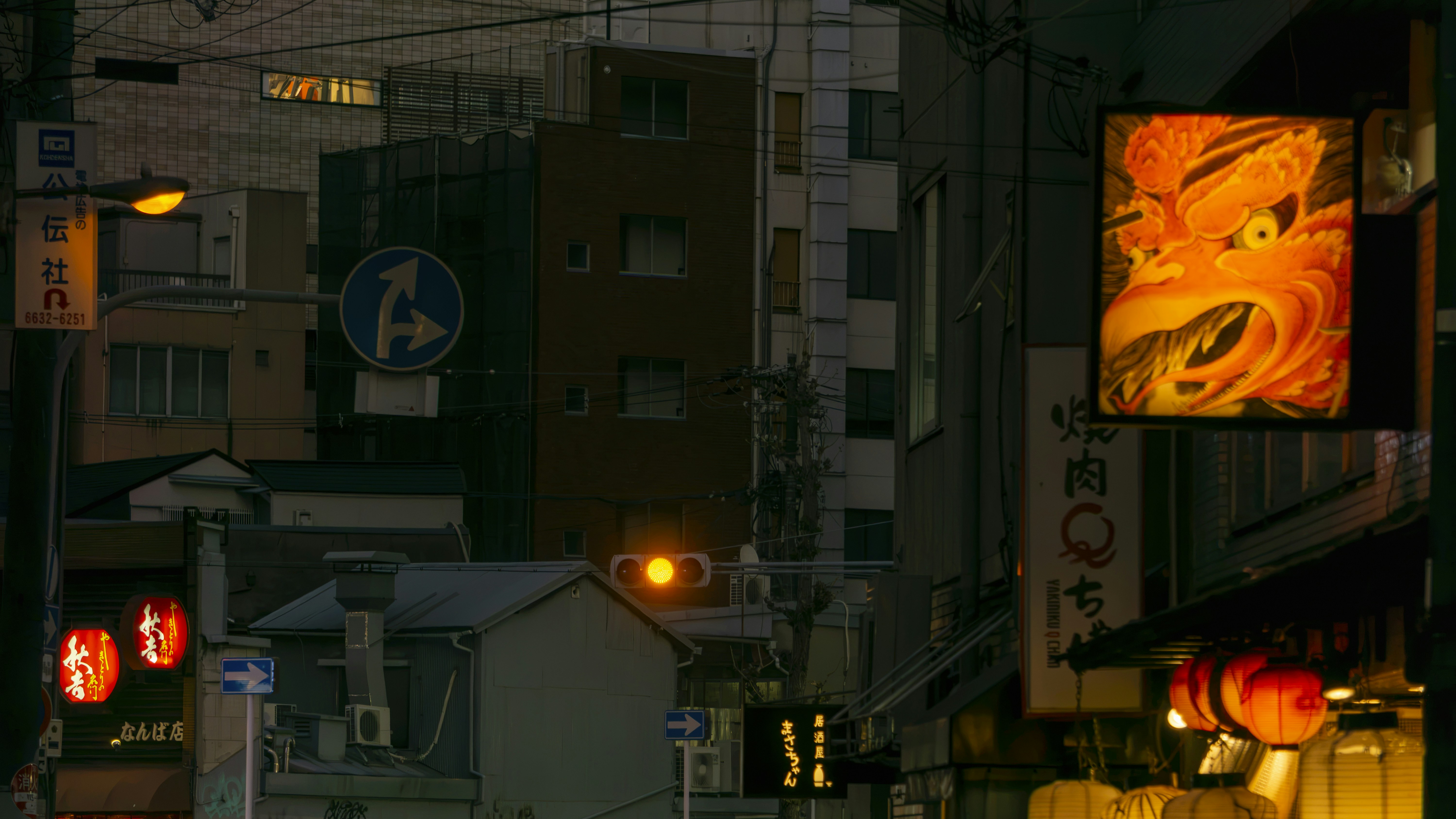 City street scene with illuminated signs and a large glowing panel on the right, capturing urban nightlife ambiance.