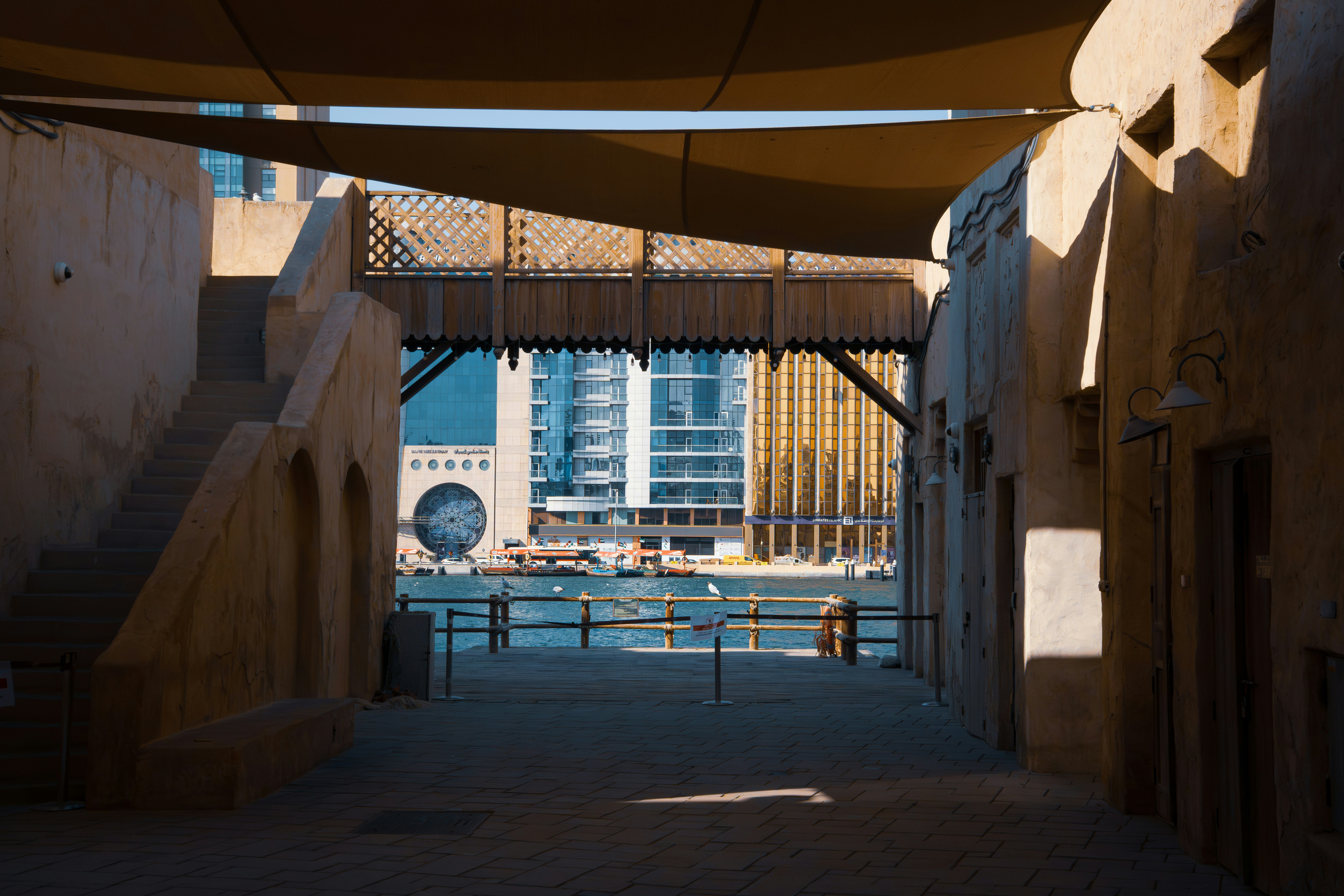 Canvas of Light: A Waterfront Passage Under Beaconed Shade