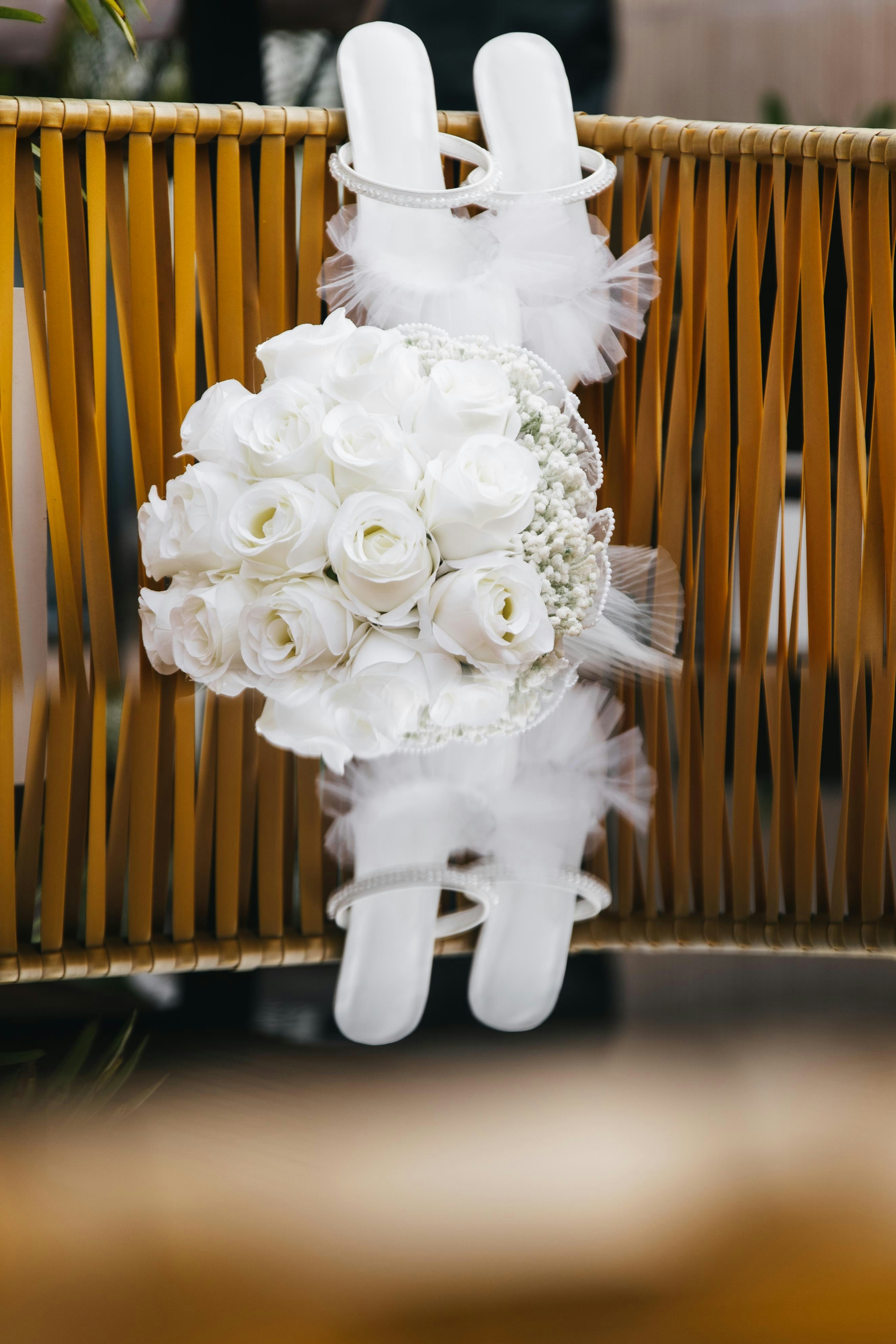 White bouquet framed by rattan arch: a bridal harmony