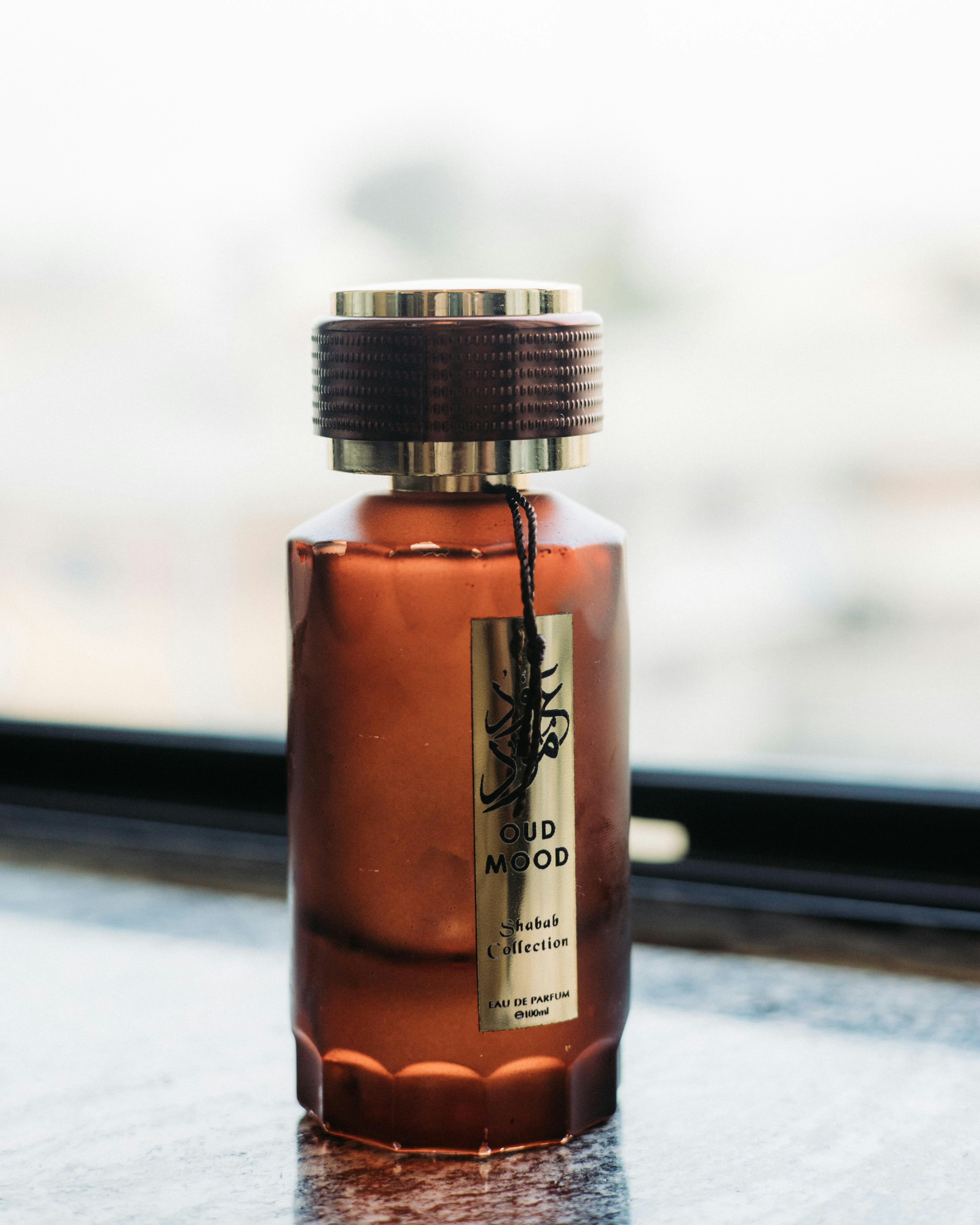Amber Essence: A Bottled Scent in Soft Window Light