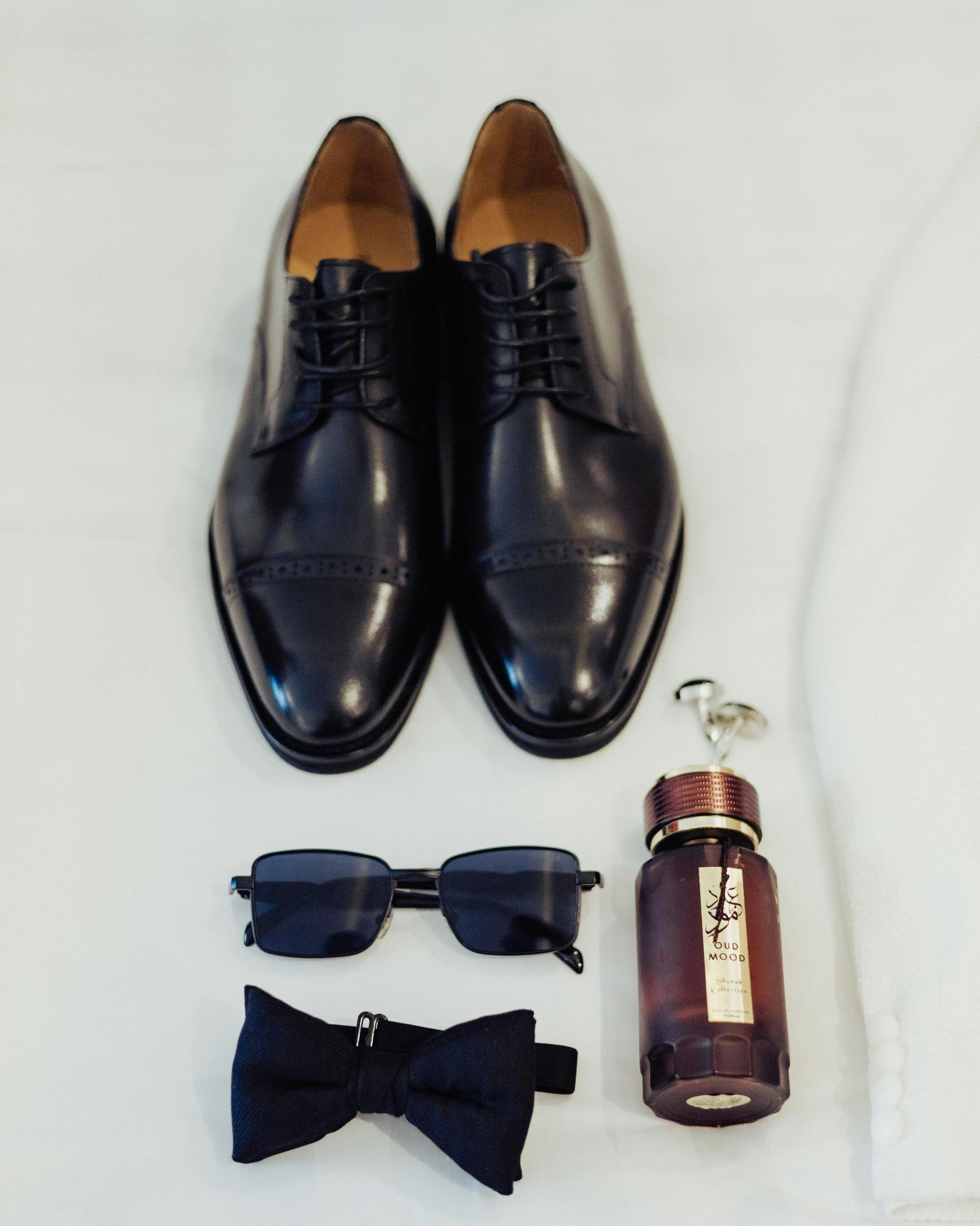 Polished Essentials: A Sharp Assembly of Shoes, Sunglasses, and Cologne