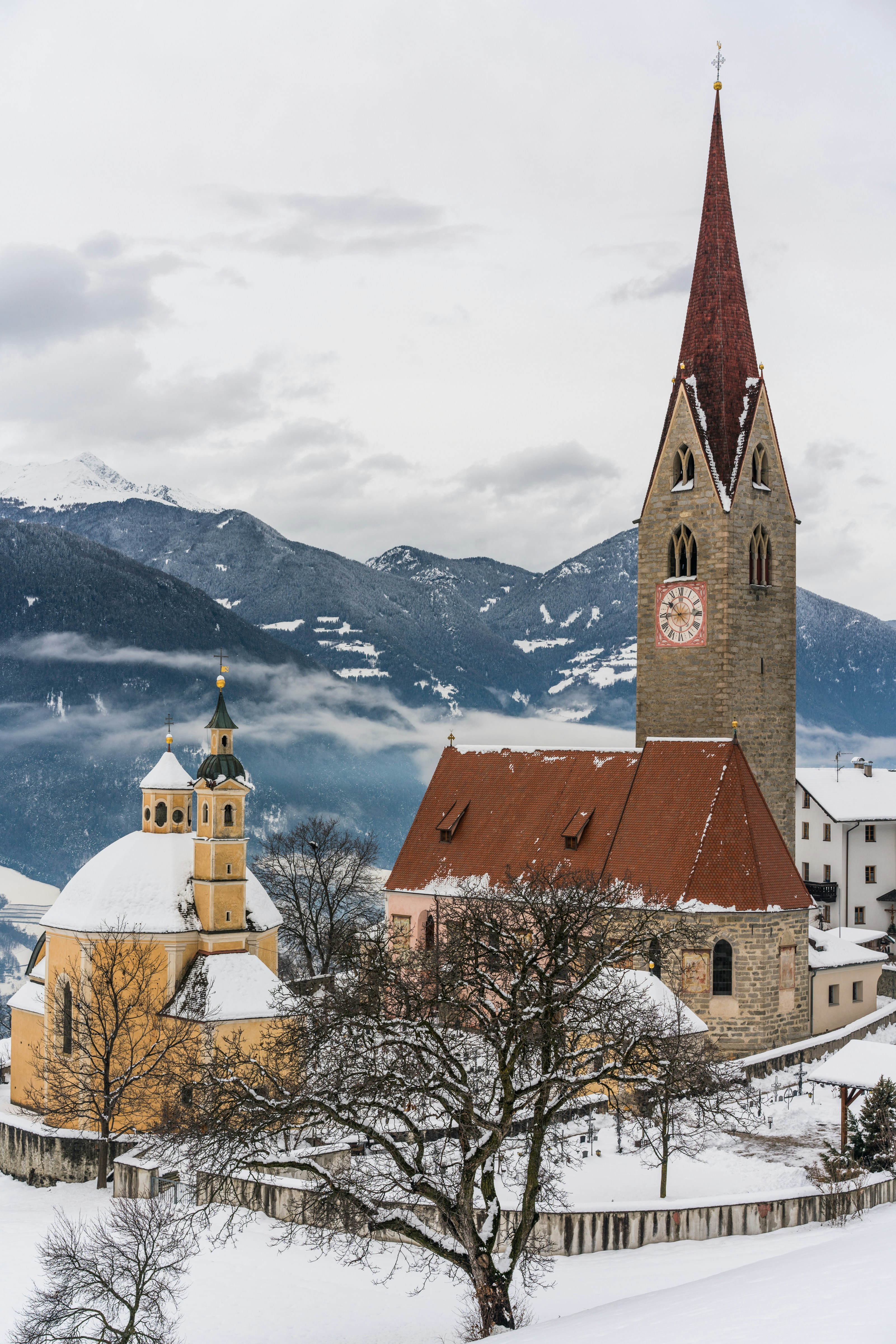 Snowbound Village Spire: A Timeless Alpine Portrait