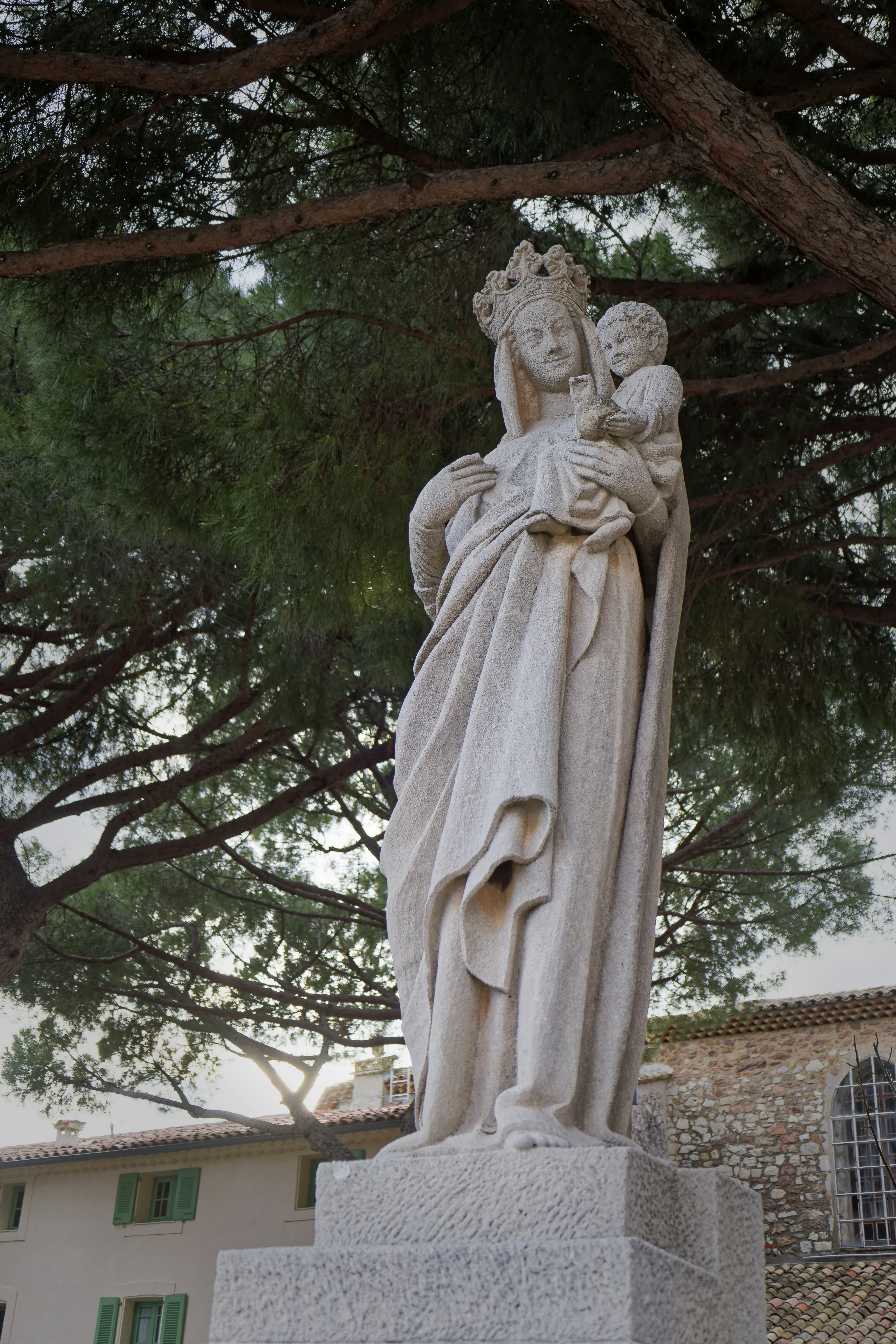 Stone Virgin with Child under a Canopy of Pines