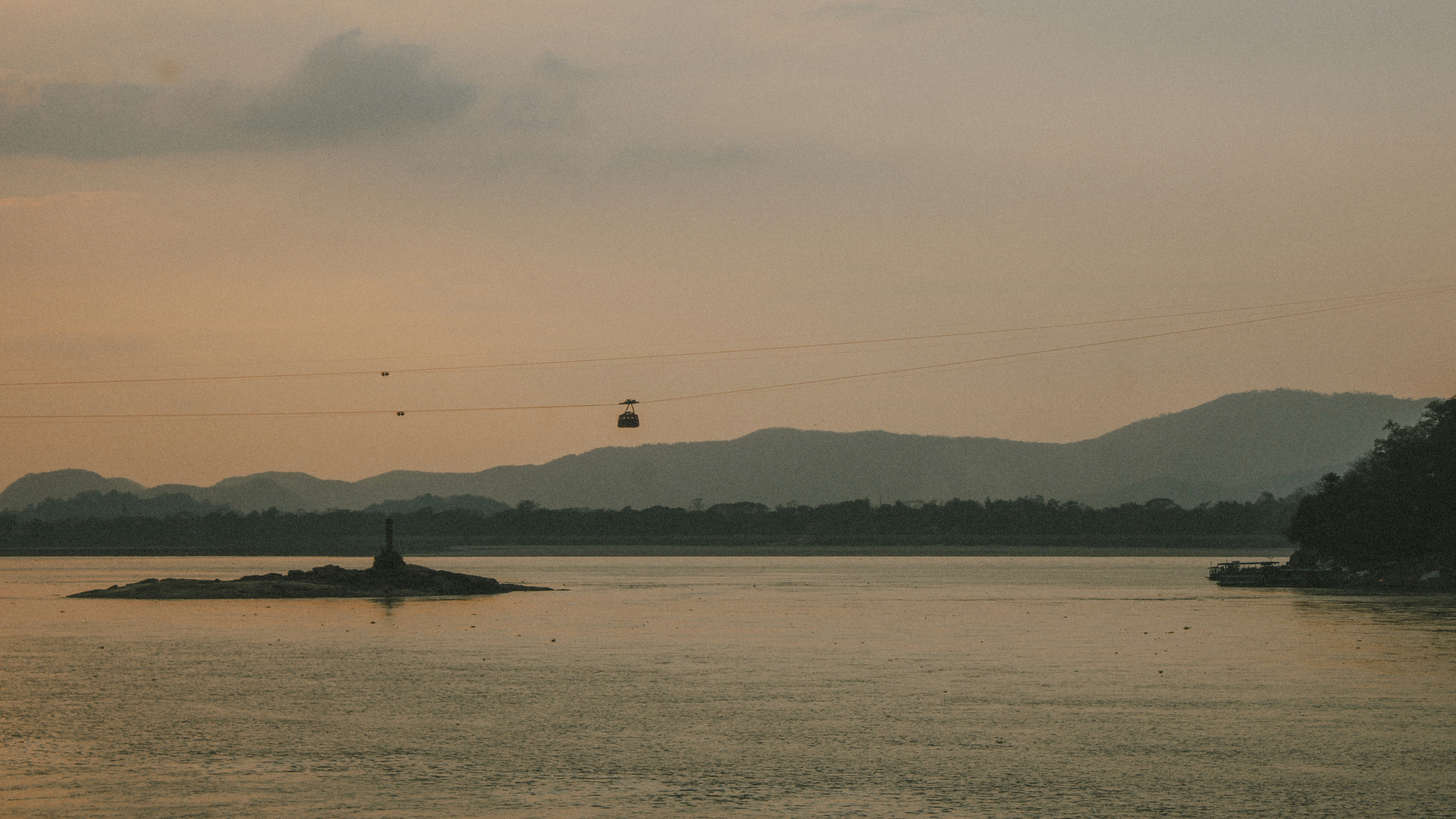 Calm Sunset Cable Car silhouettes over a tranquil waterway