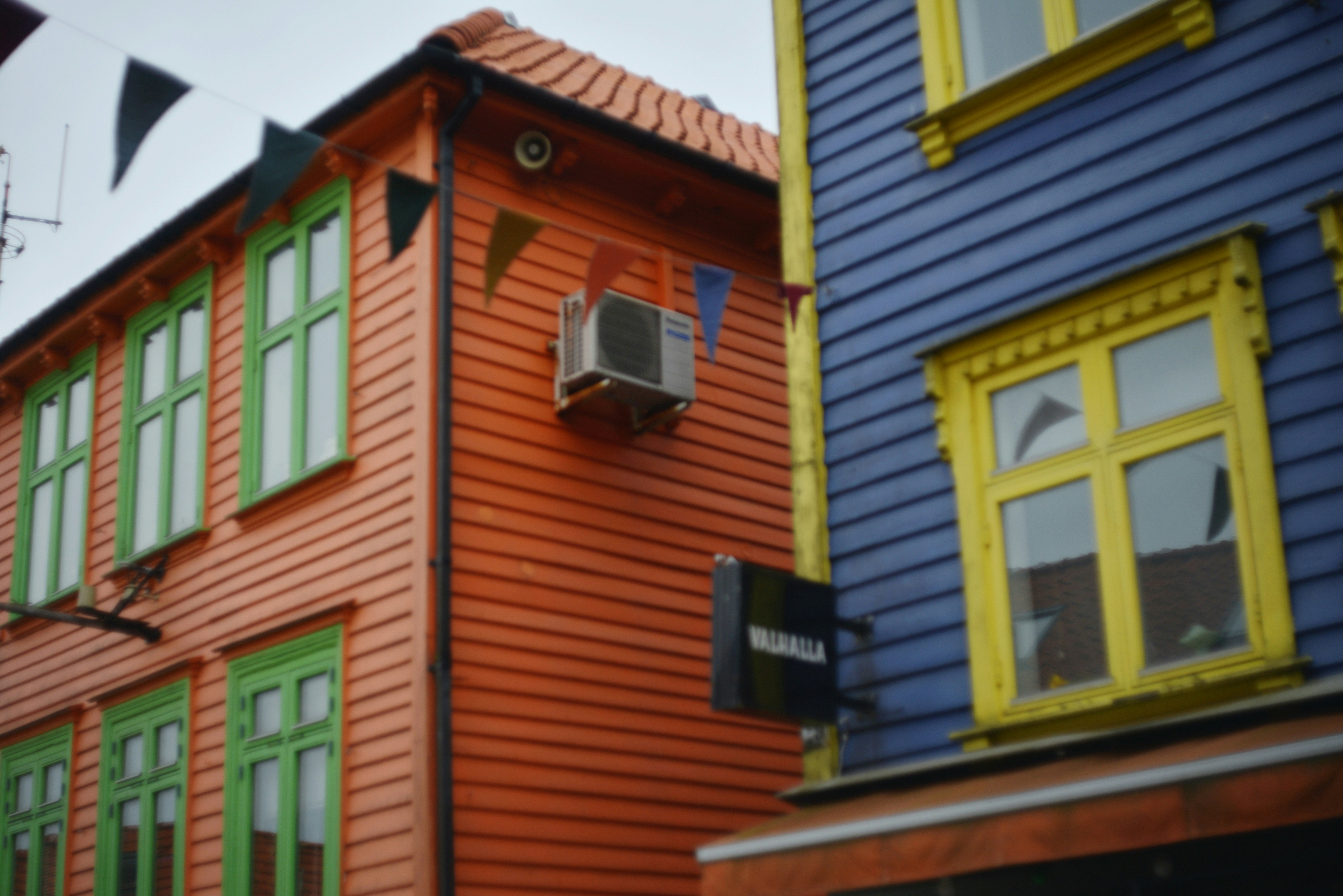 Colorful Facades: A Street Corner withOrange, Green, and Blue Woodwork