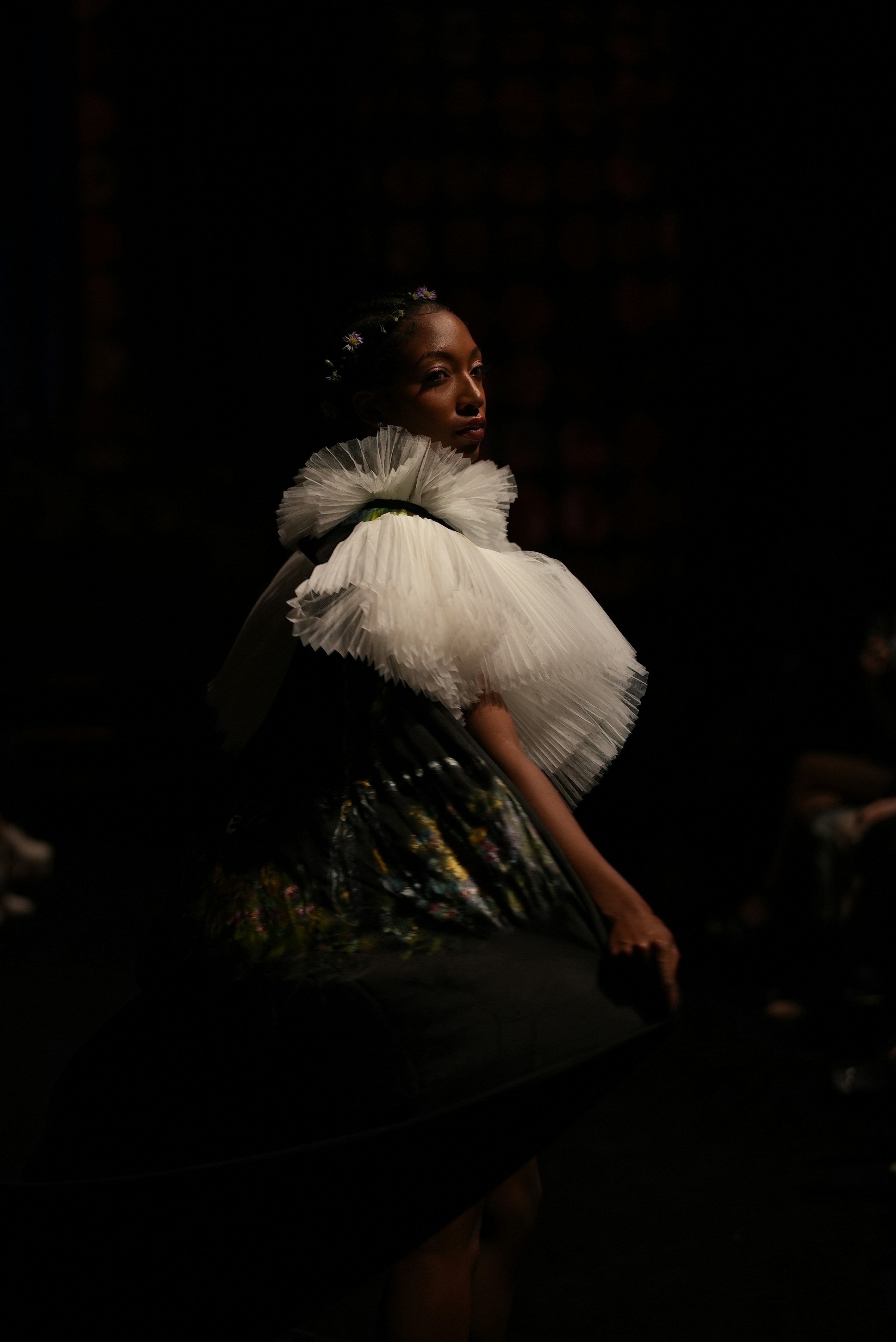 Elegance in Spotlight: The Dancer in White Pleats