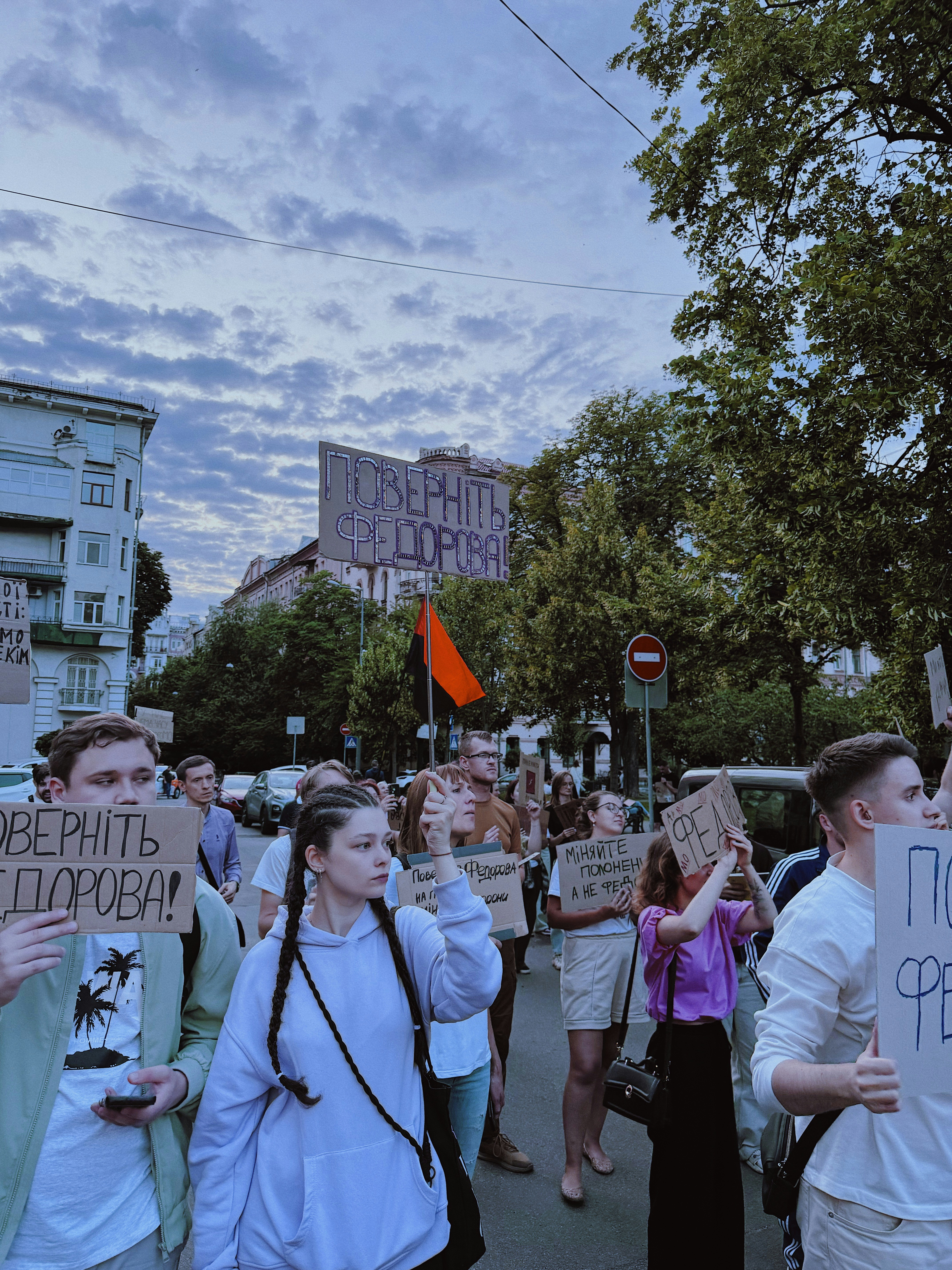 Protest in the City: Voices Raised with Signs Under a Blue-Gray Sky