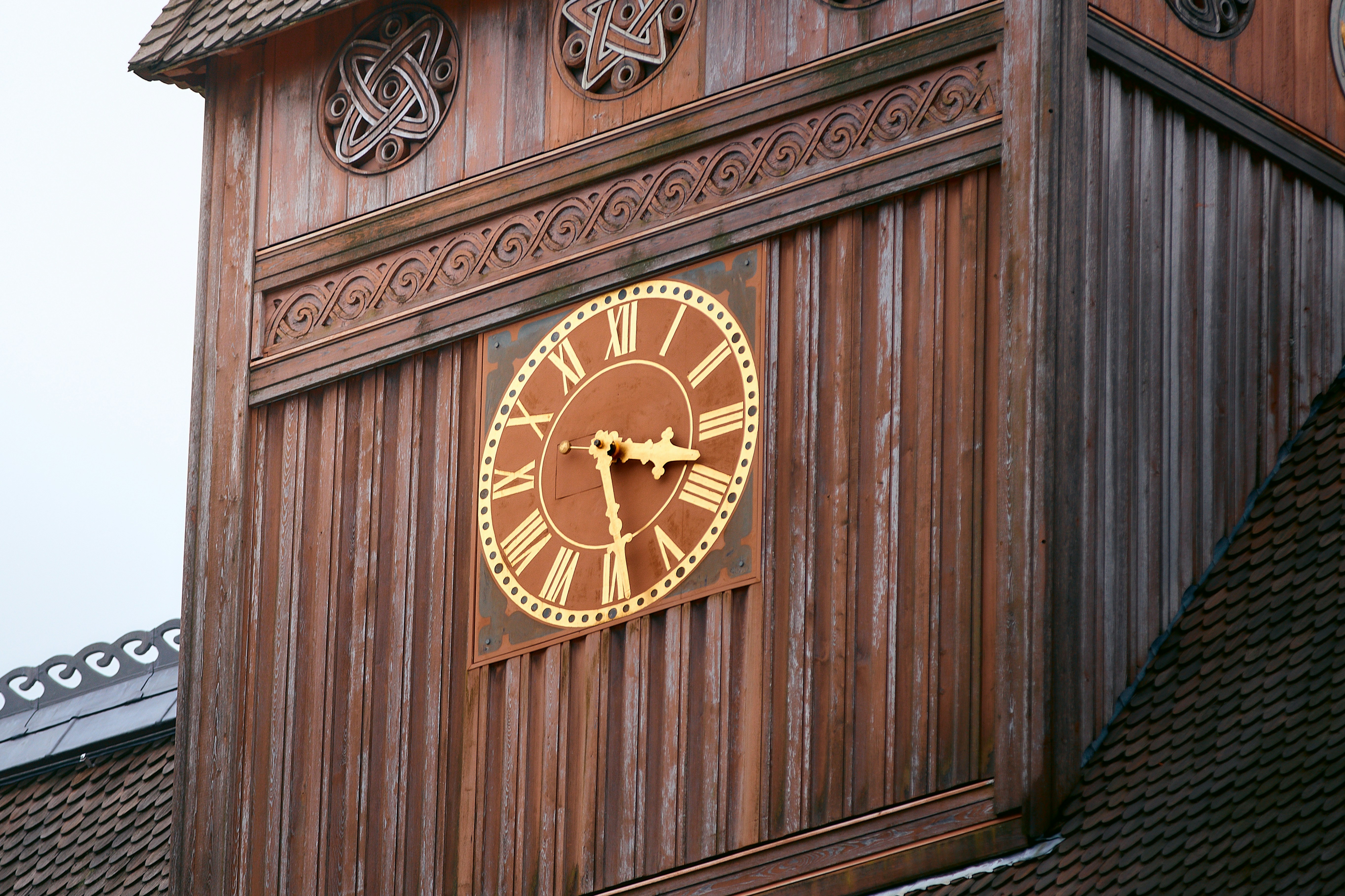 Wooden Clock Tower with Golden Roman Dial