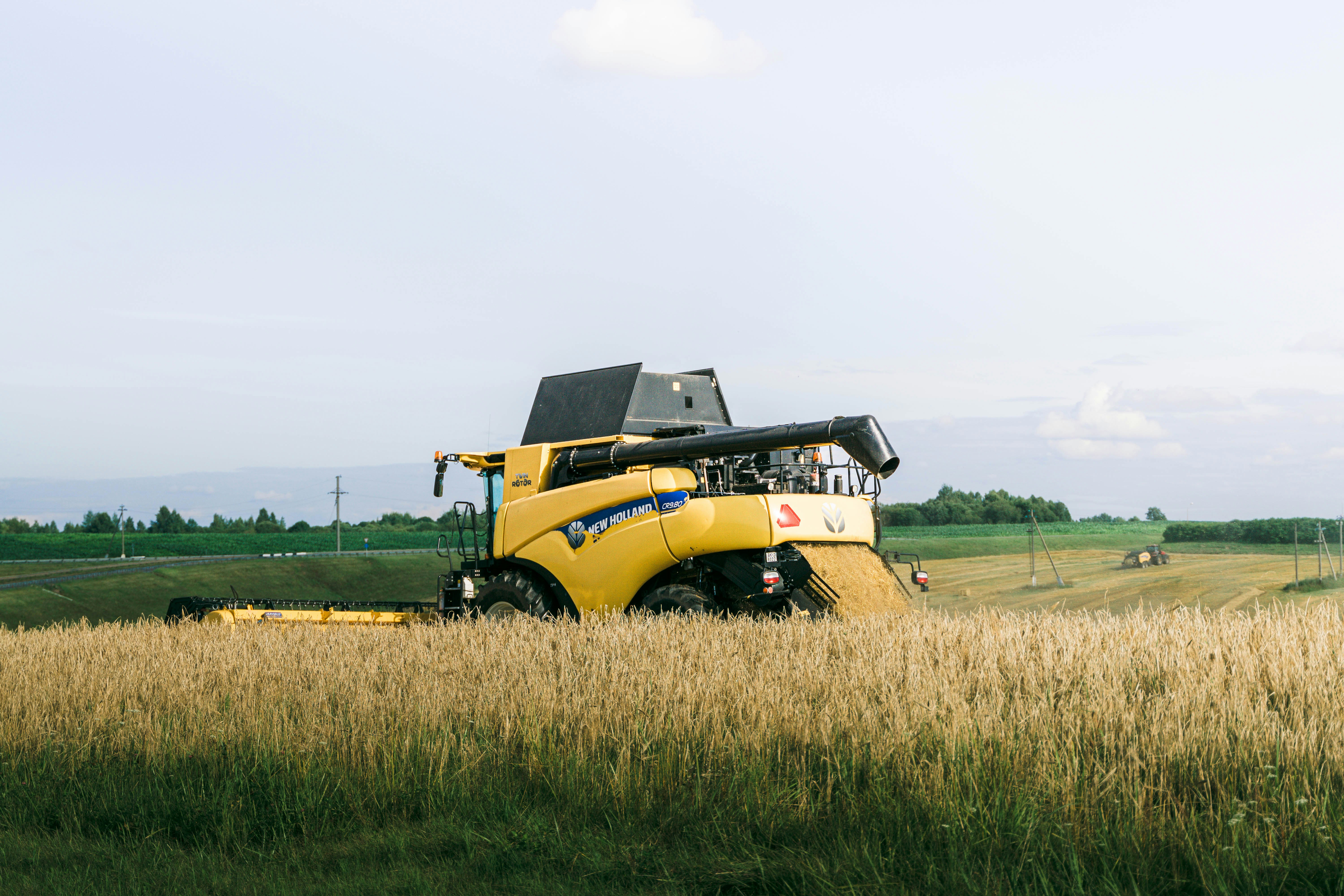 Harvesting Sunlight: A Yellow Combine Resting in a Golden Field